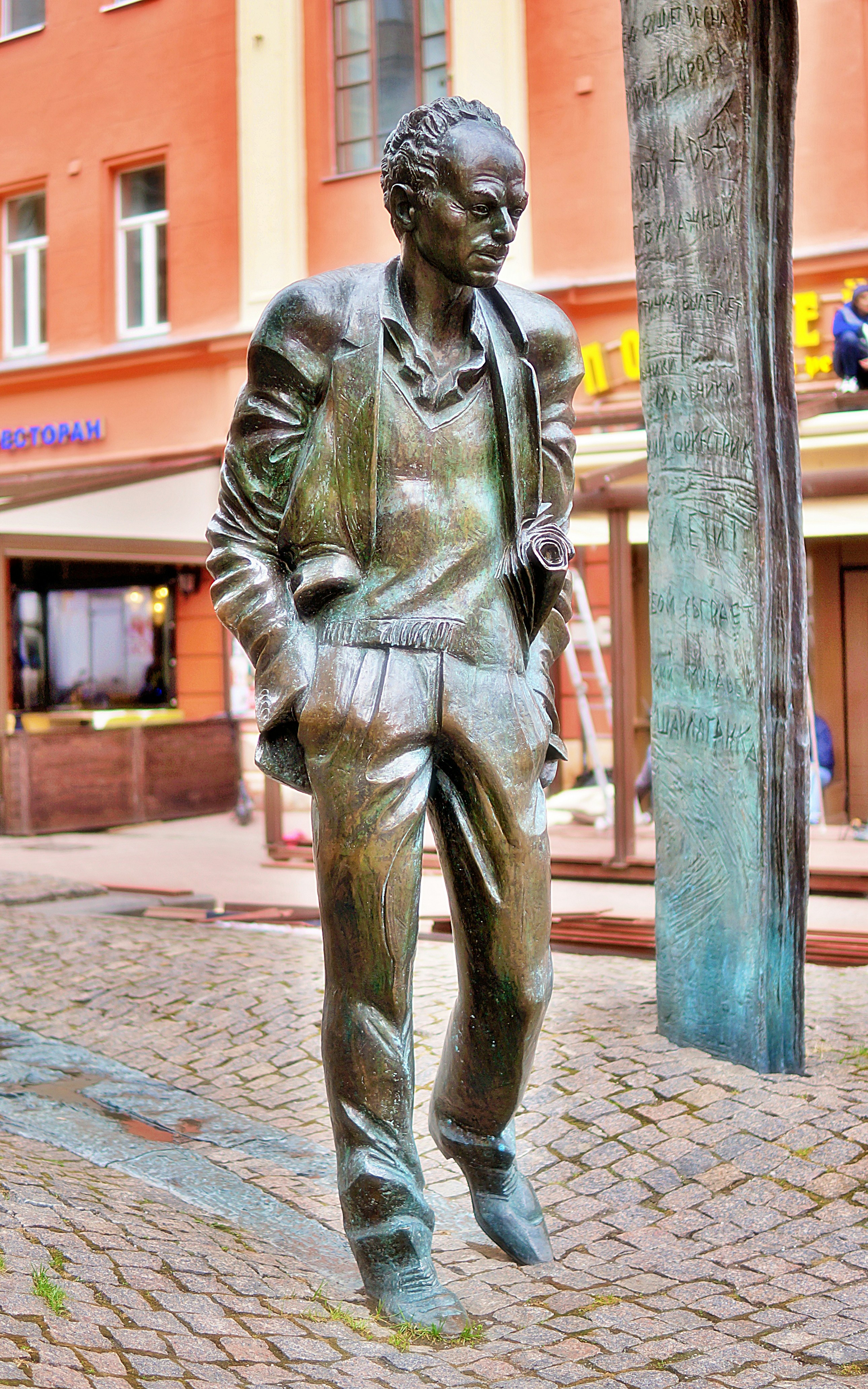 Bronze Dreamer: A Leaning Figure Beneath a City Beam