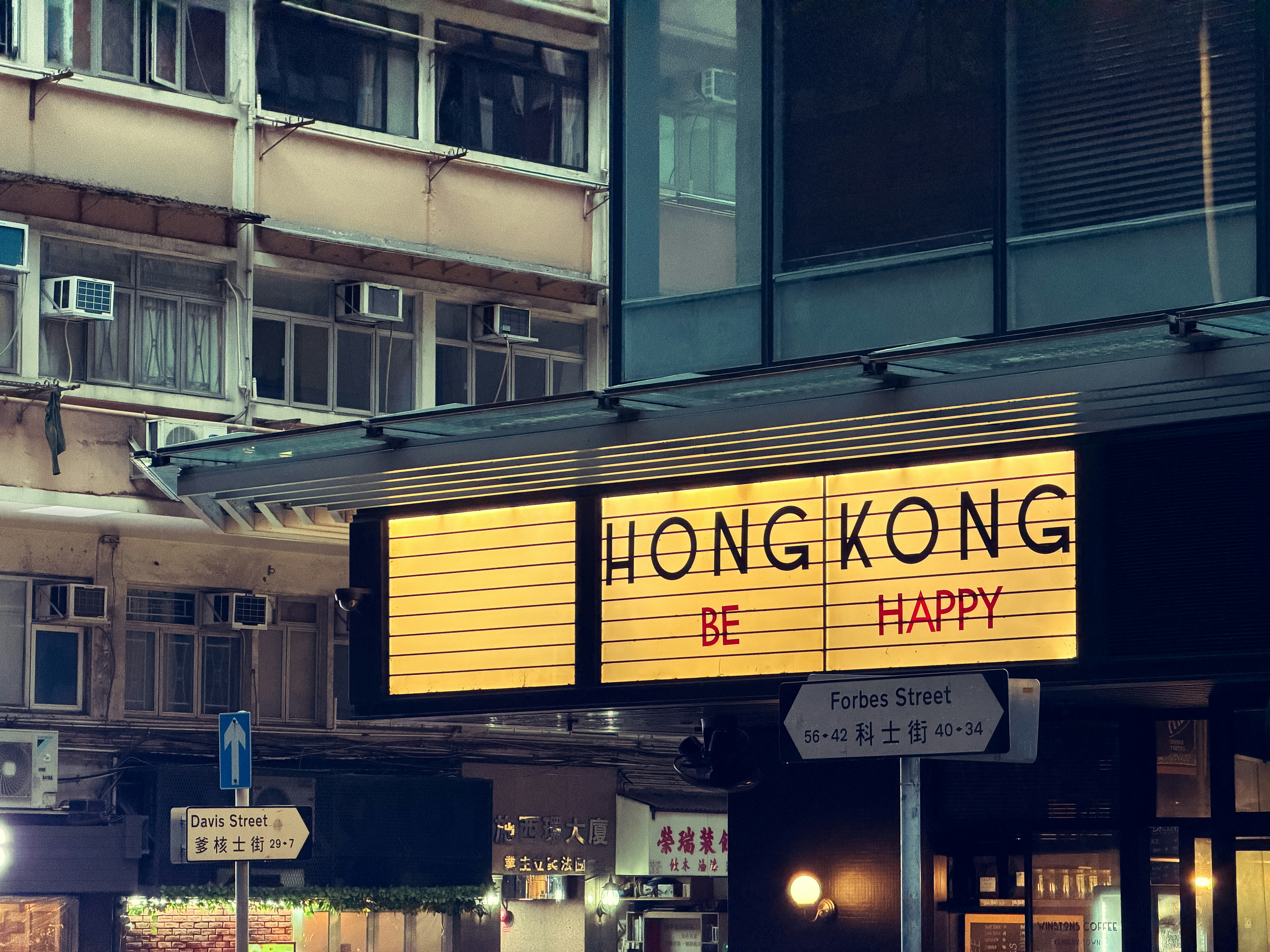 Hong Kong Be Happy Neon: A Busy Signboard Above the Street