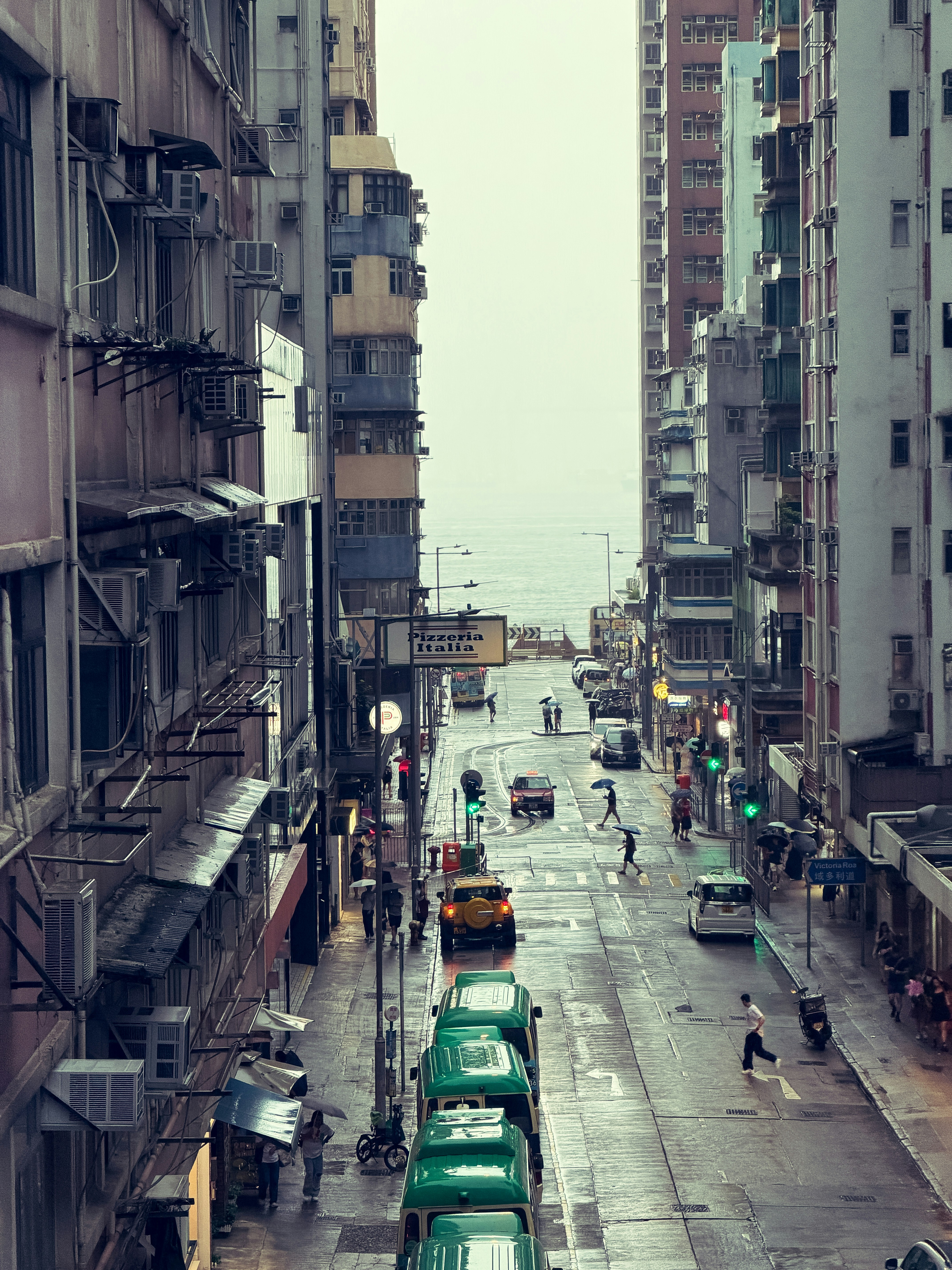 Between Towers to the Sea: A Rain-Slick Corridor of City Life
