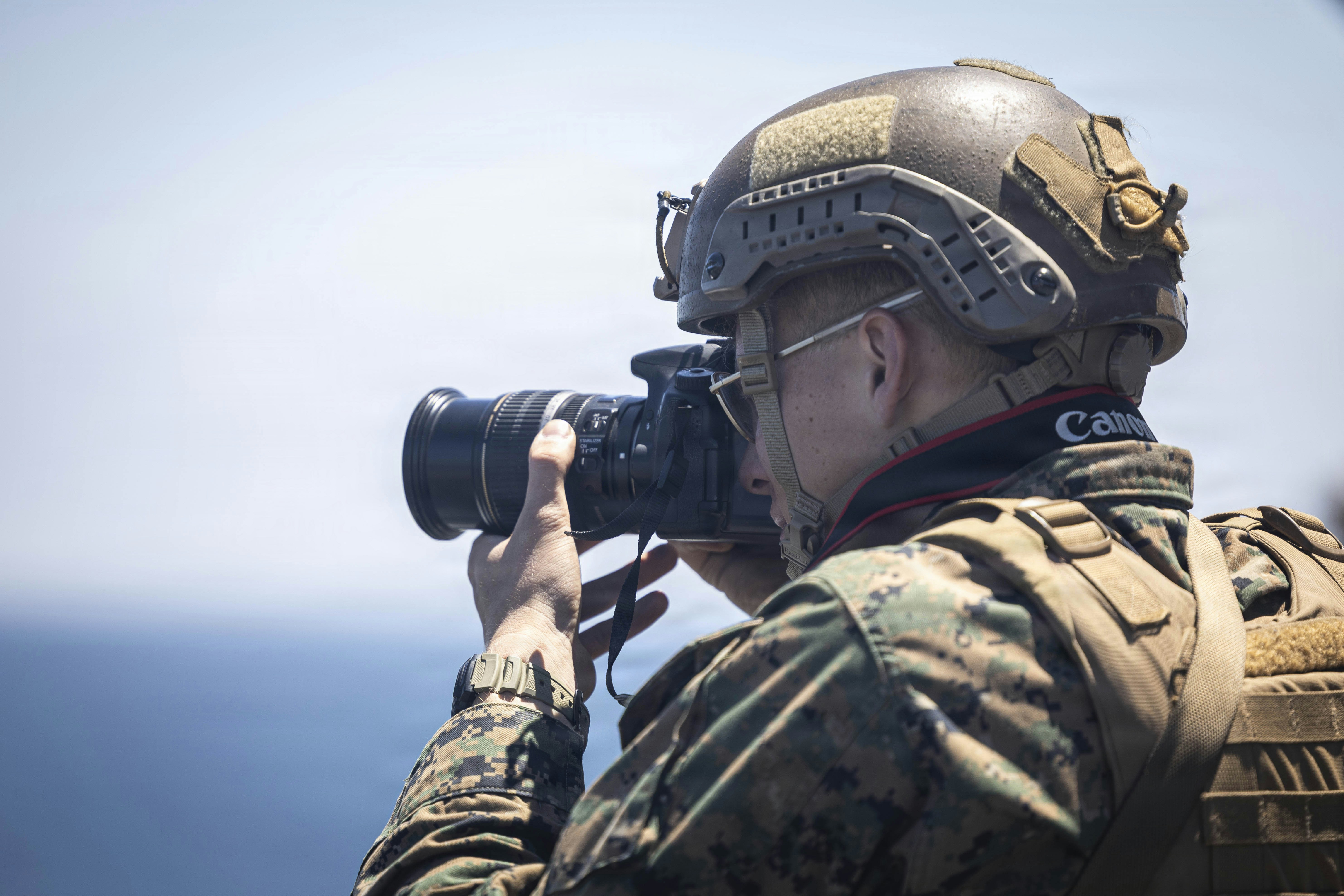 Battlefield Focus: Soldier in Profile with Camera Ready for Action