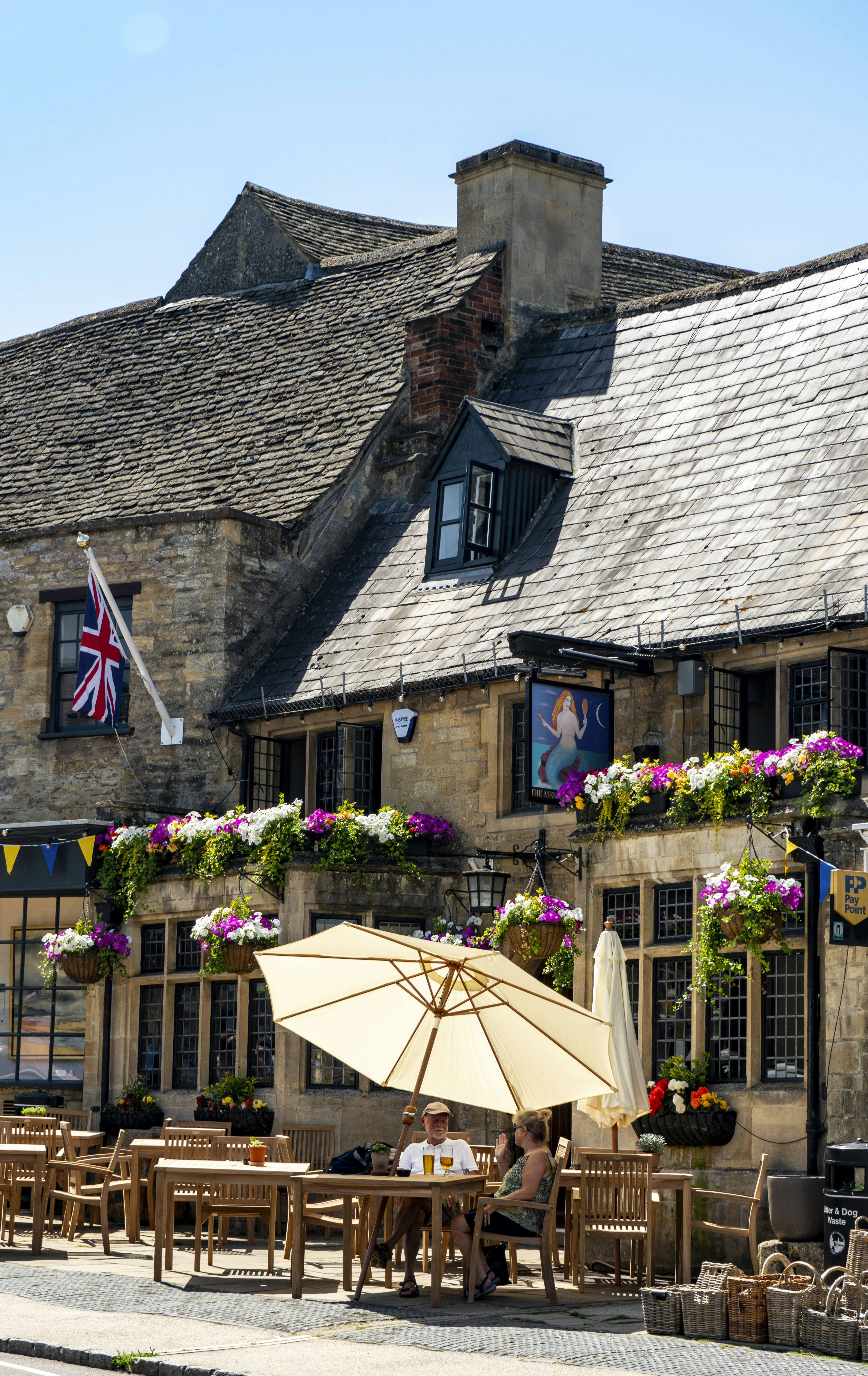 Café Terrace Under a Village Banner