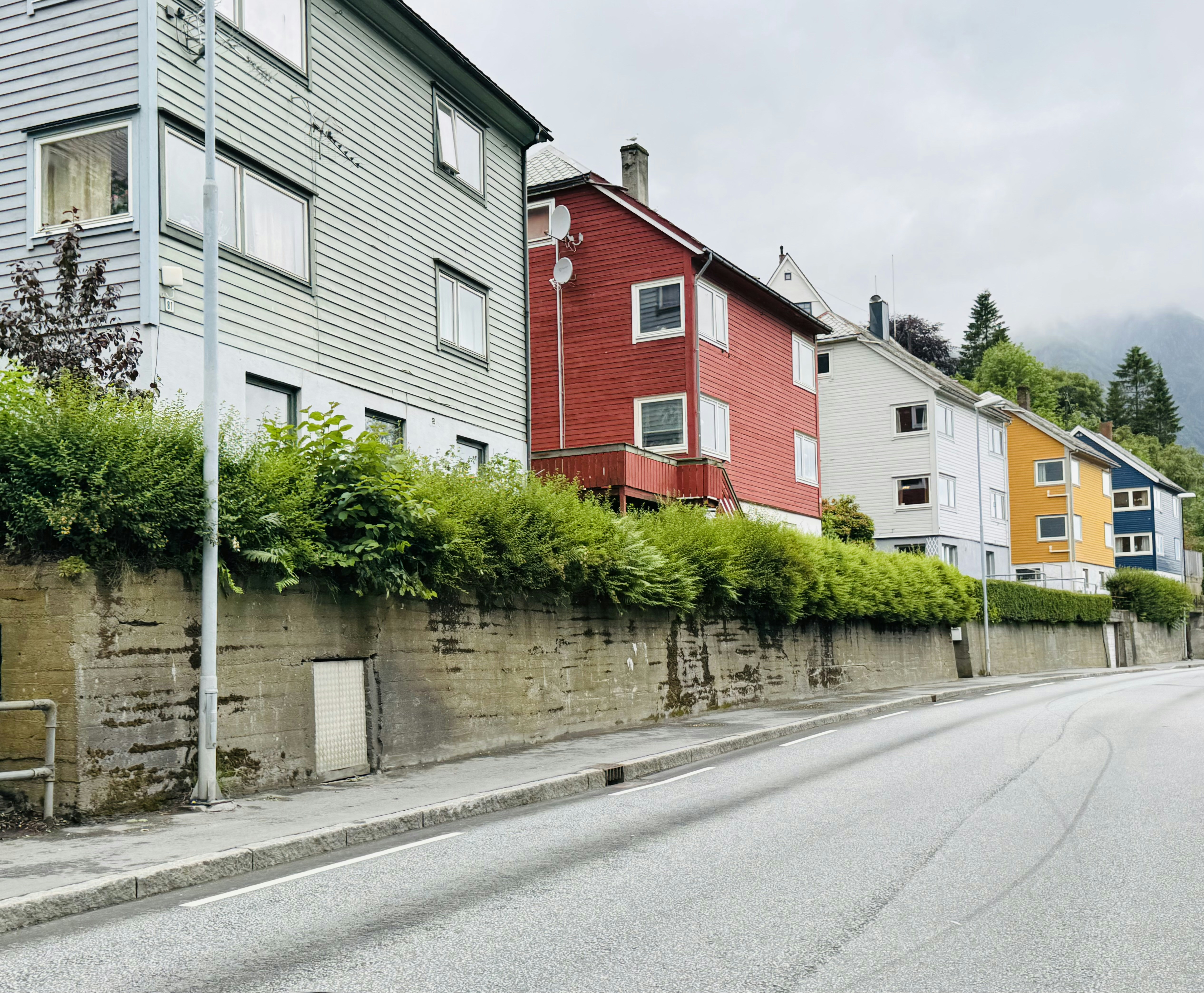 Row of Painted Townhouses Over a Quiet Sloped Street