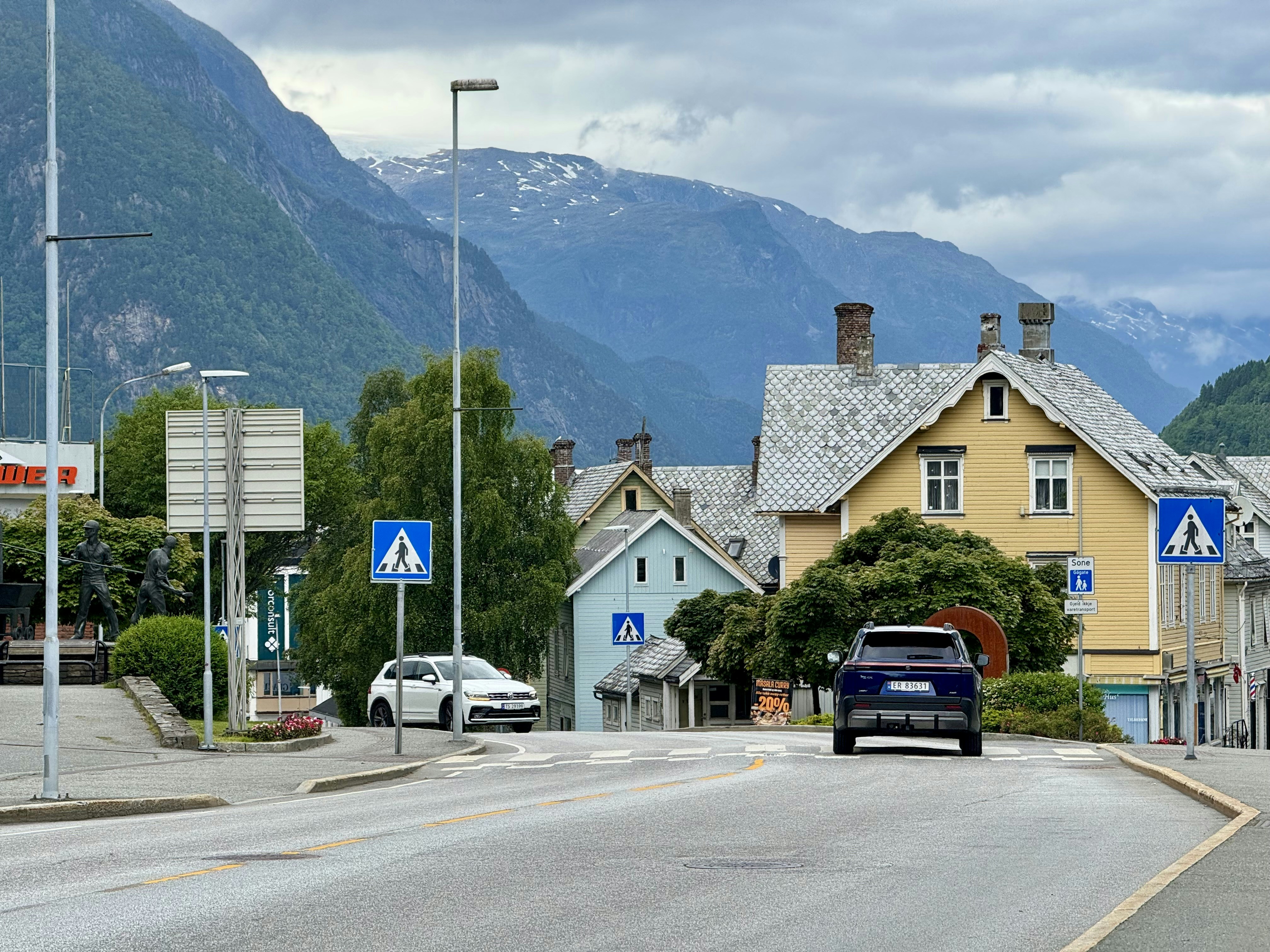 Pastel houses lining a quiet mountain town street