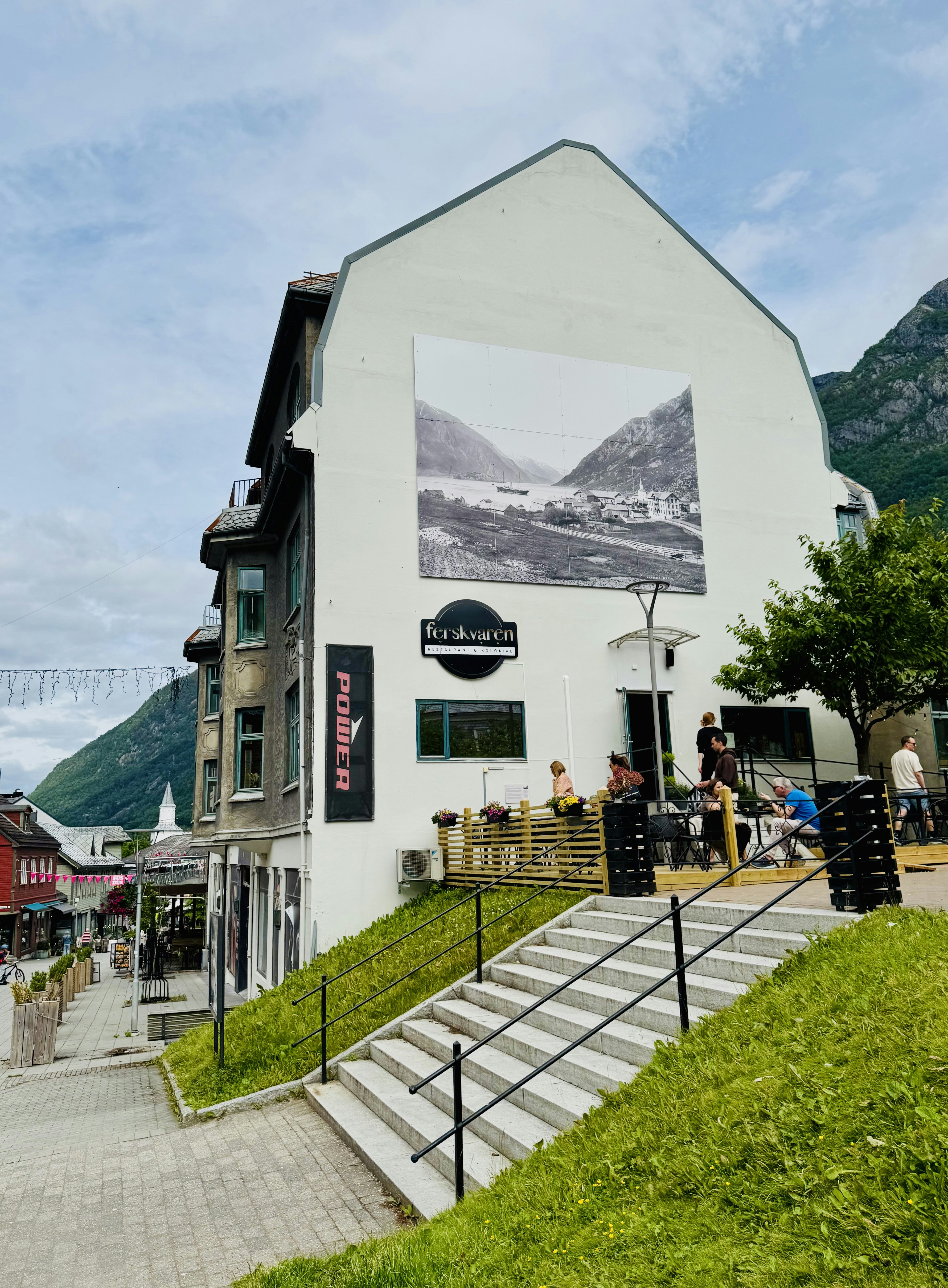 Facing the Mountain Bistro: A White Facade Café in a Alpine Village