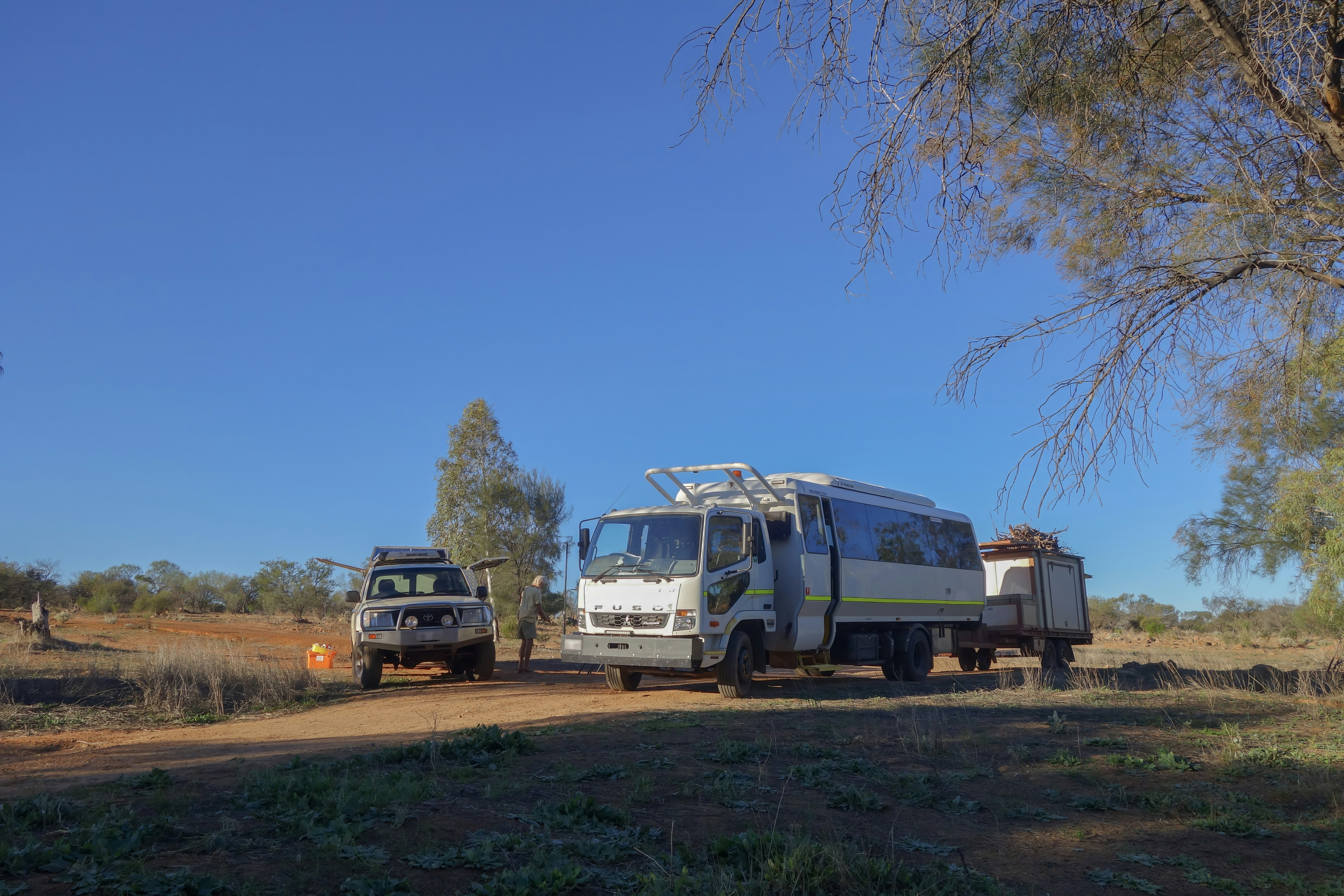 Desert Camp: Vehicles Rest under a Wide Sky