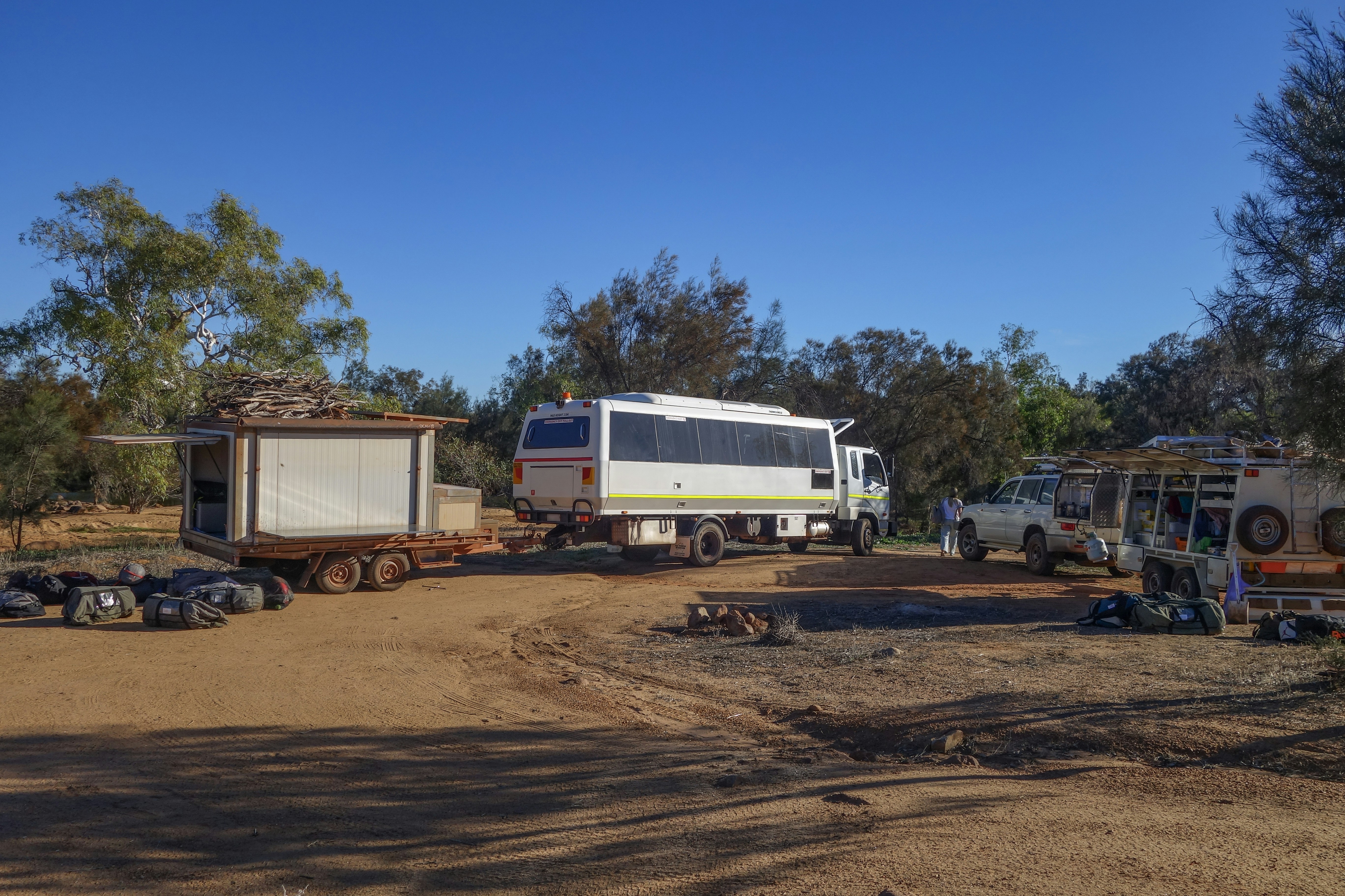 Desert Base Camp: Buses and Workshop in a Quiet Clearing