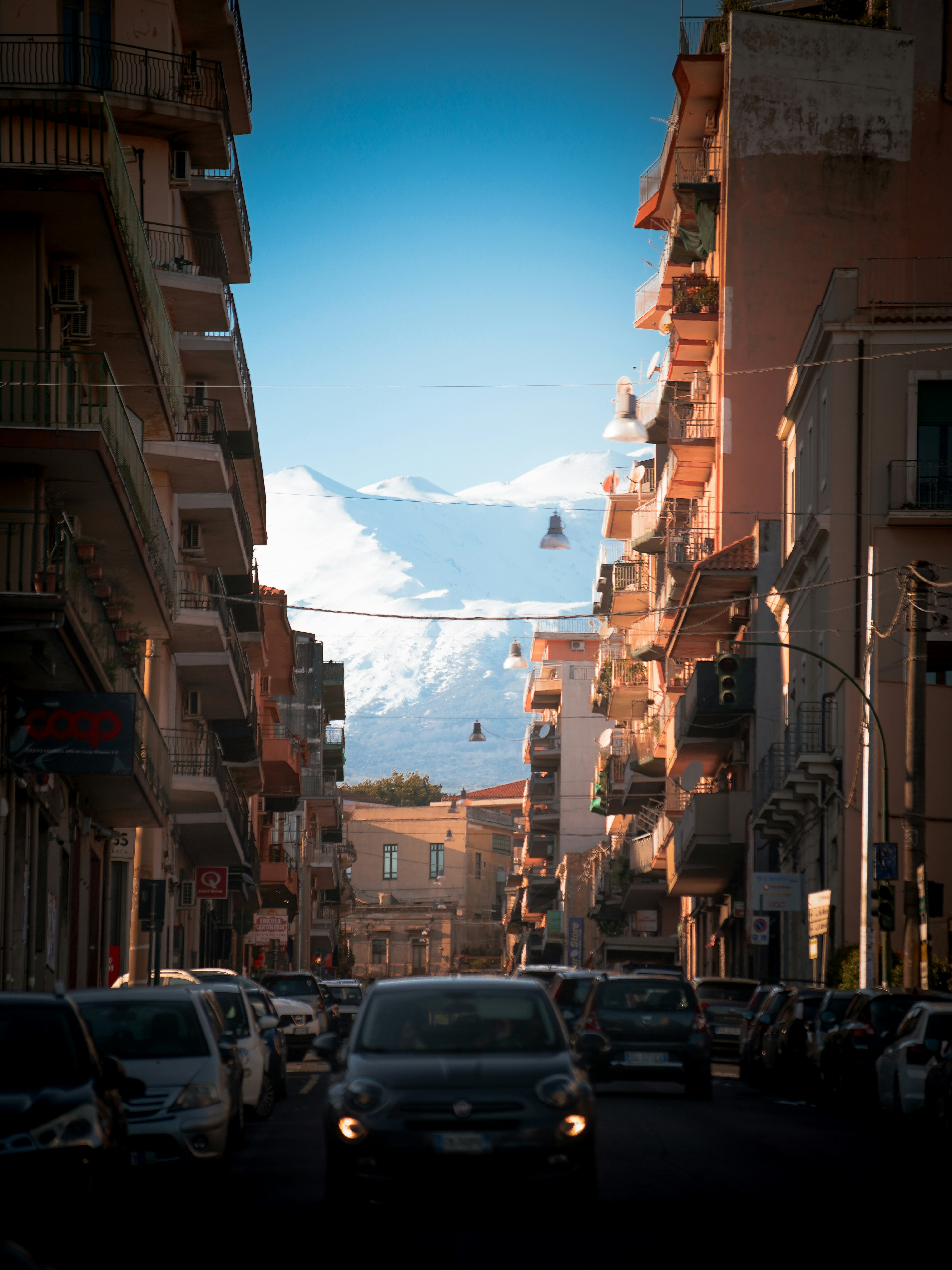 Snow-Capped Summit Framed by Urban Canyon