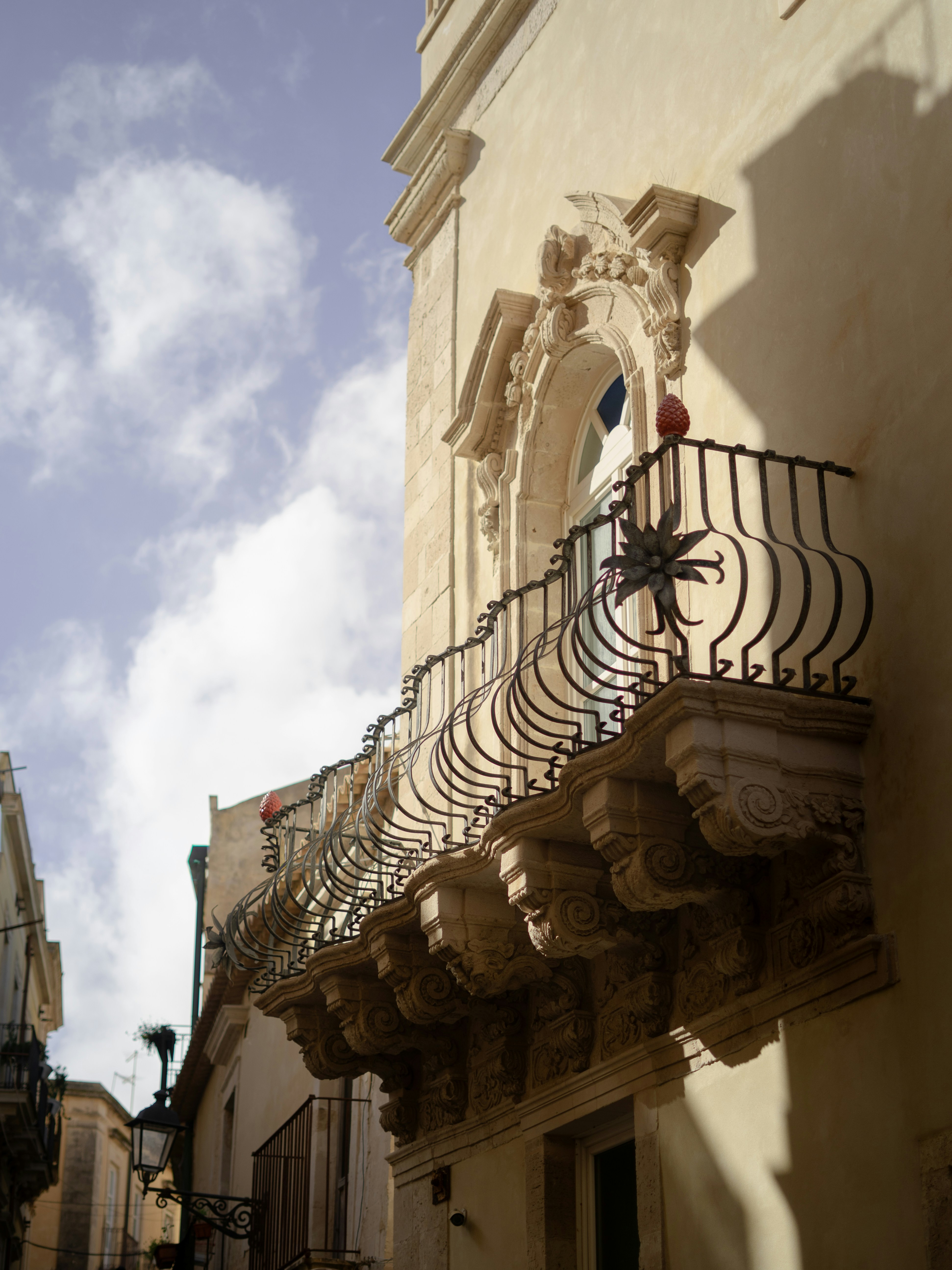 Ornate Balcony Against Warm Facade: A Mediterranean Facade in Soft Light