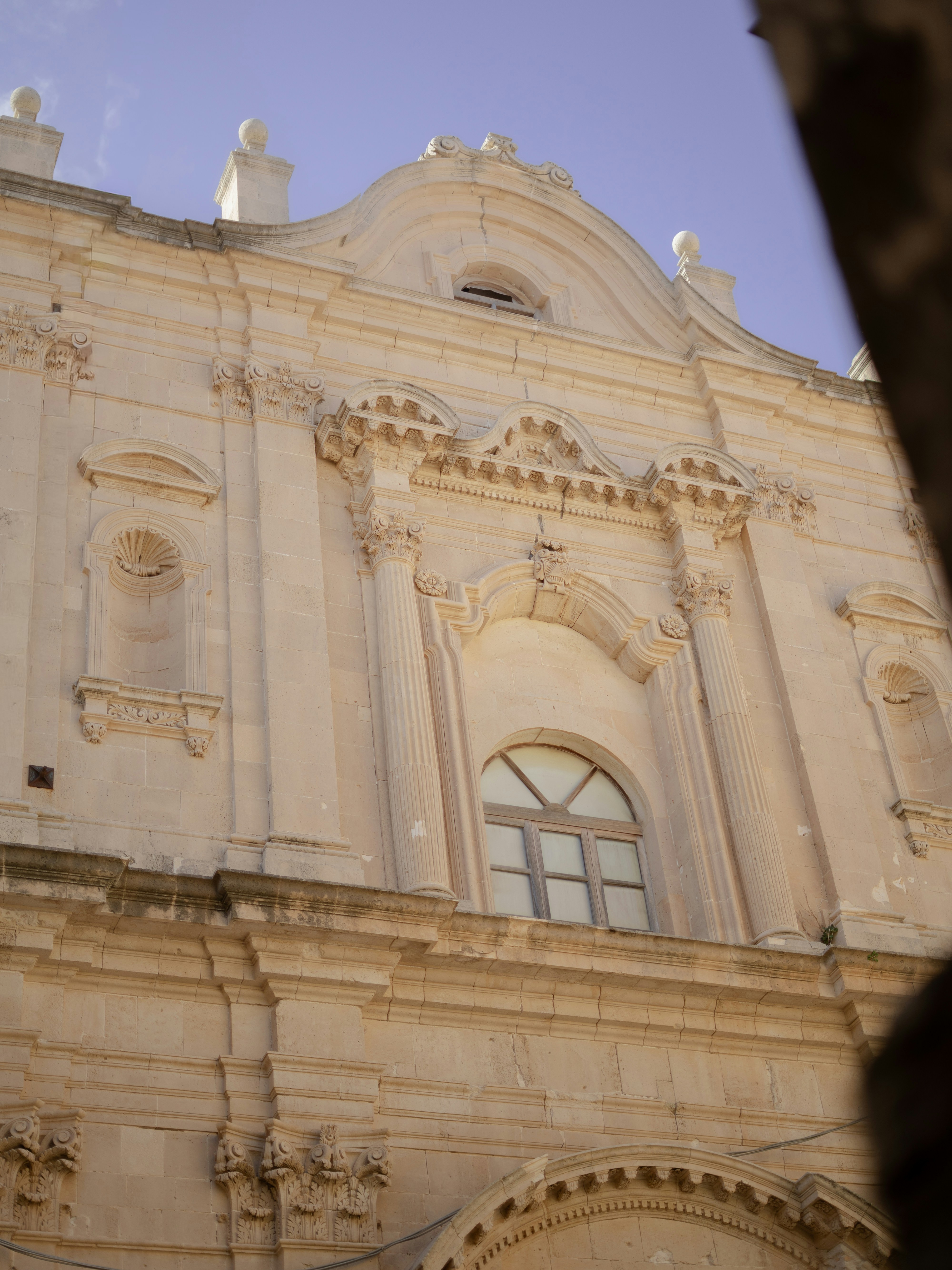 ornate façade of a historic European church rising above stonework