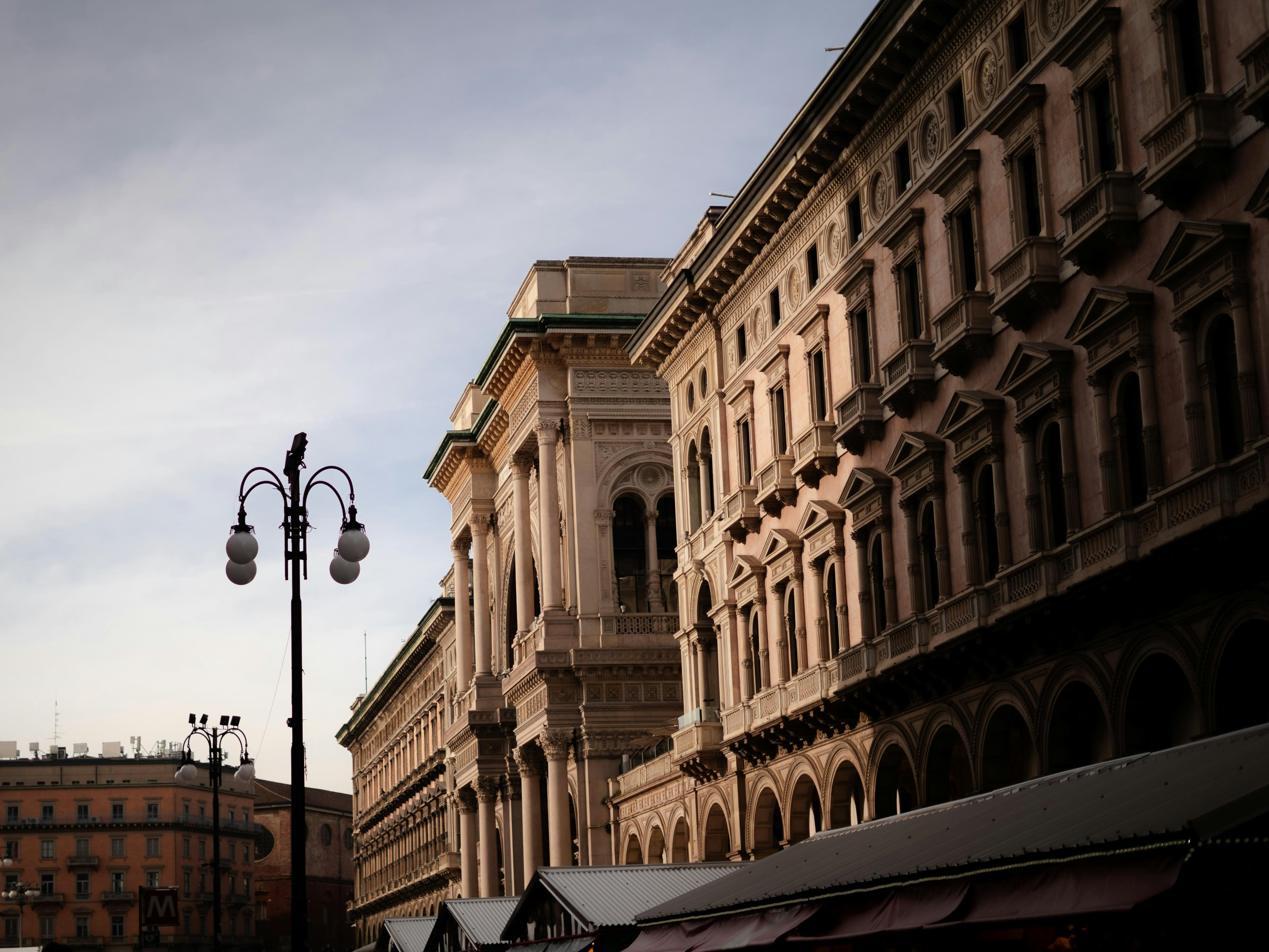 Arcade Shadows: A Sunlit Facade Across Temporal Stone