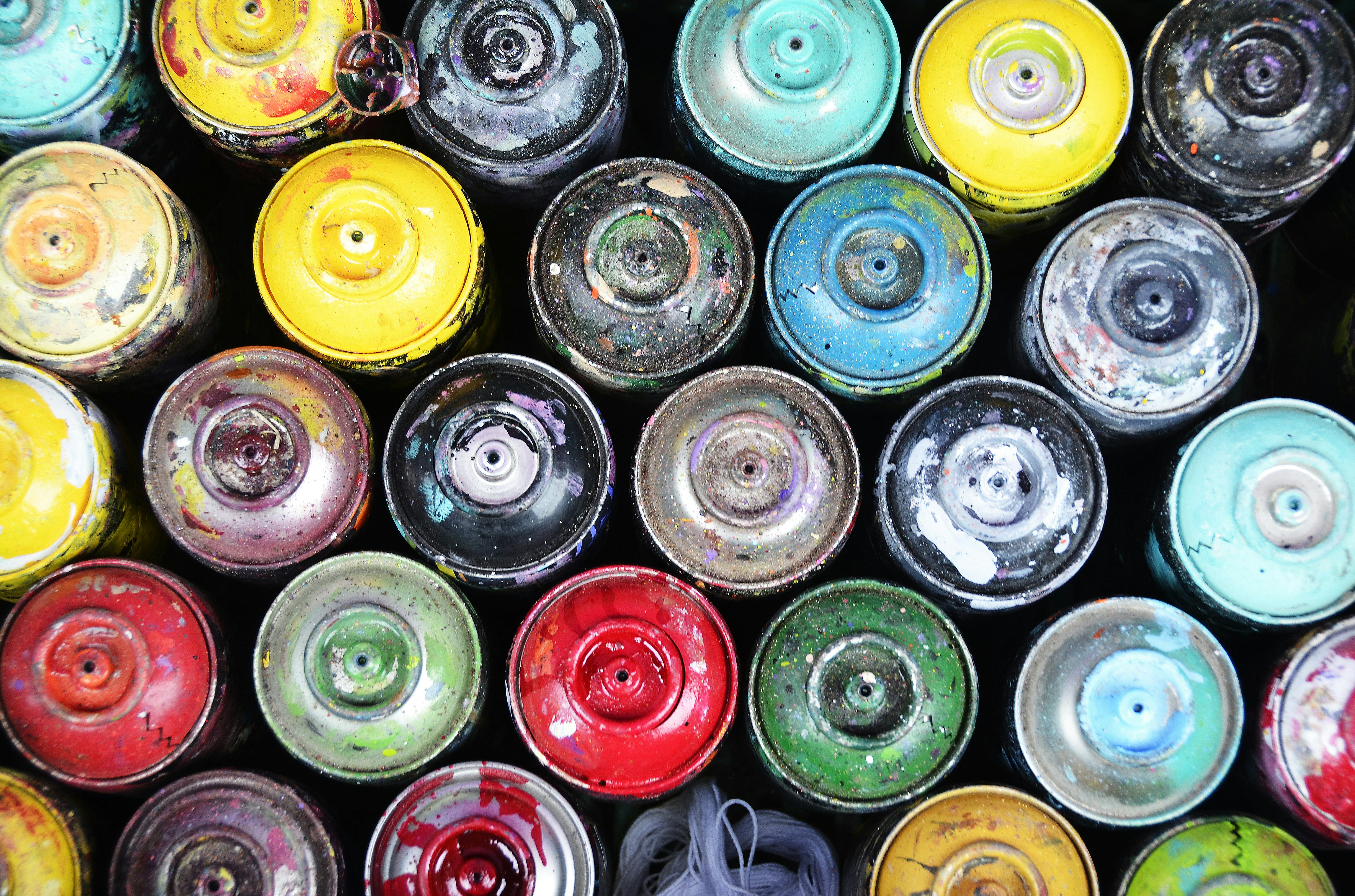 Spectrum of Aerosol: A Top-Down Canvas of Painted Cans