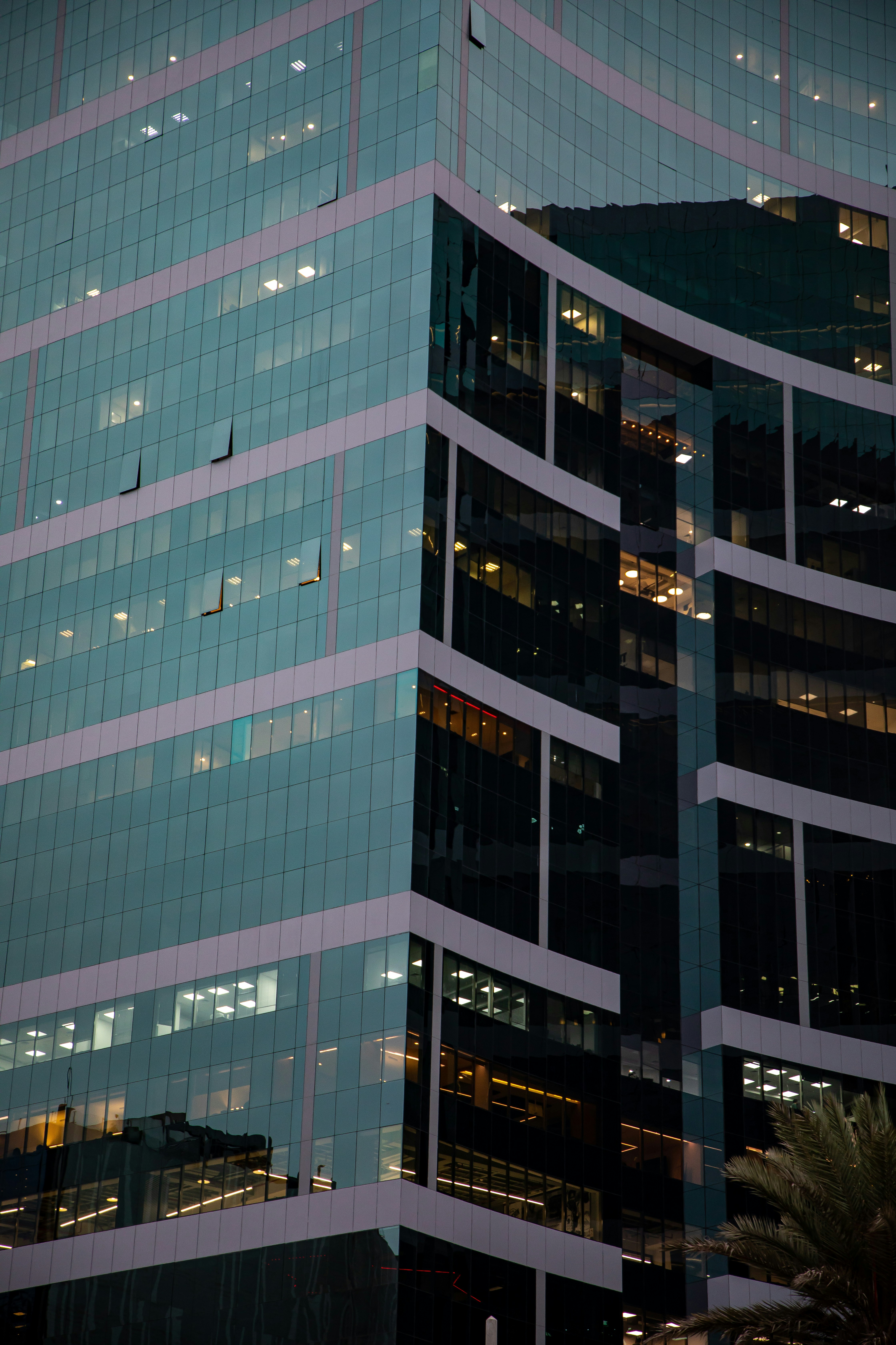 Glassy Facade Tapestry: Vertical Stripes of Light and Shadow