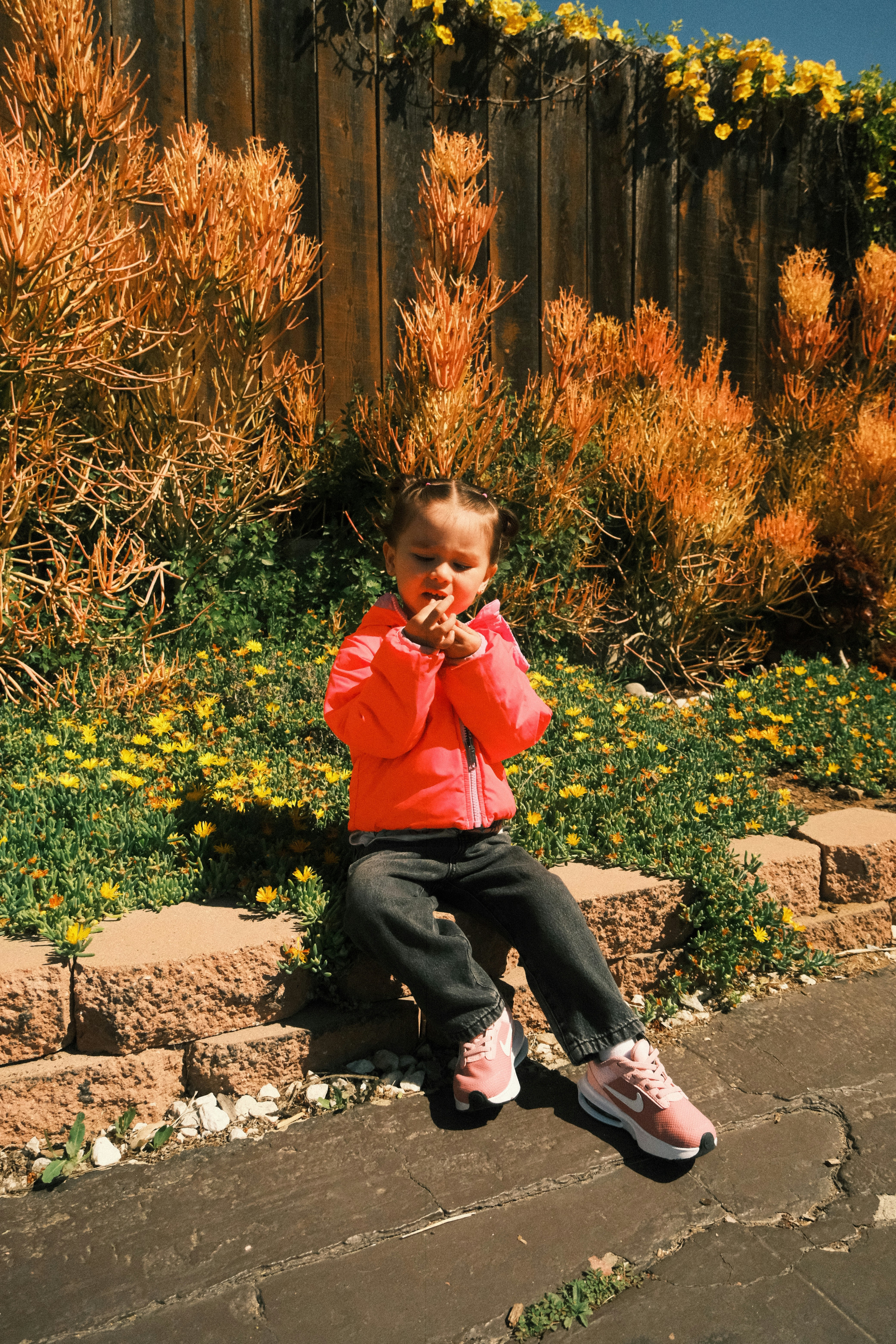 Sunlit Streetwear Moment: A Young Girl in Neon Pink Outdoors