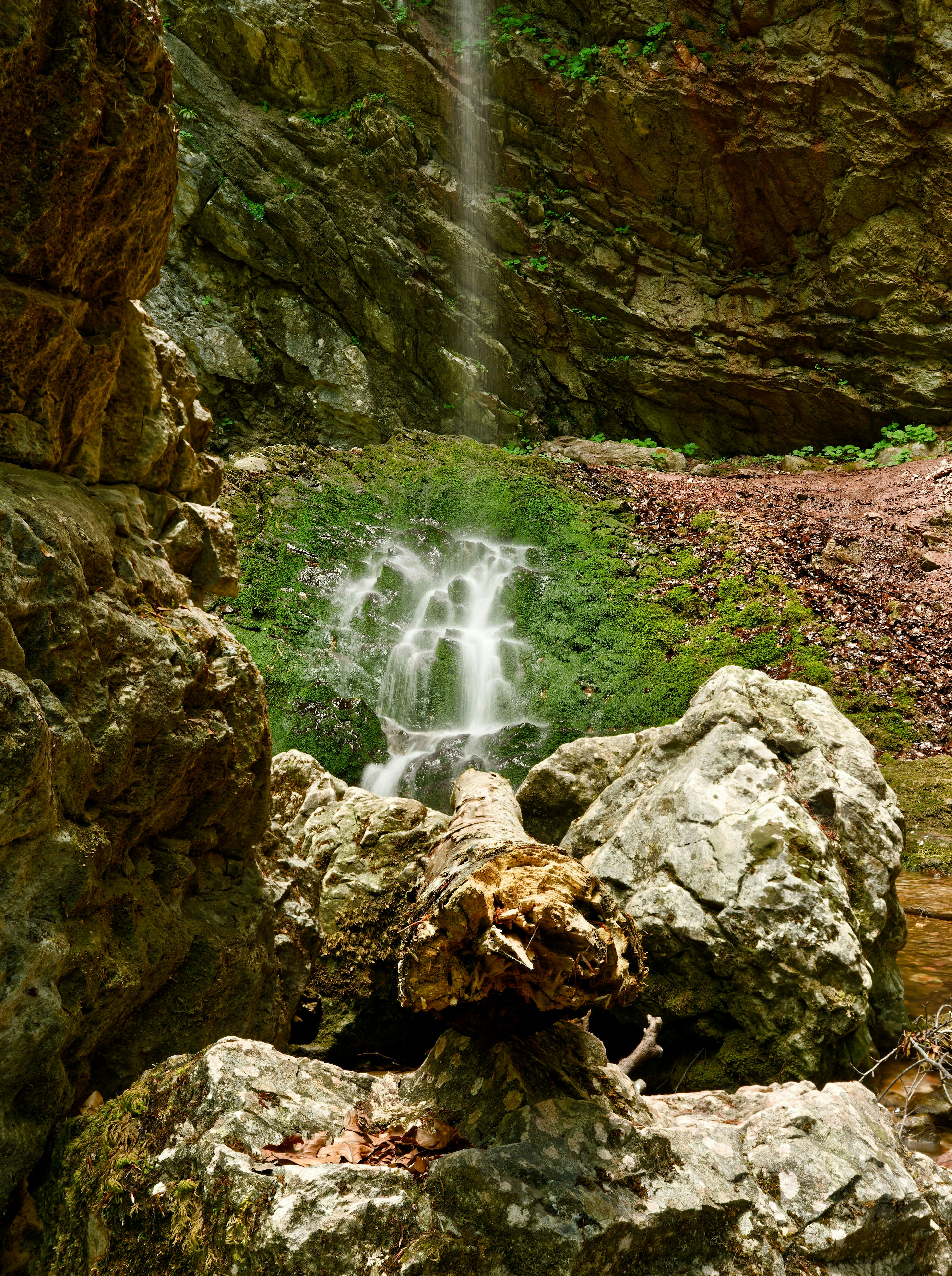 Hidden Cascade Beyond Weathered Rocks