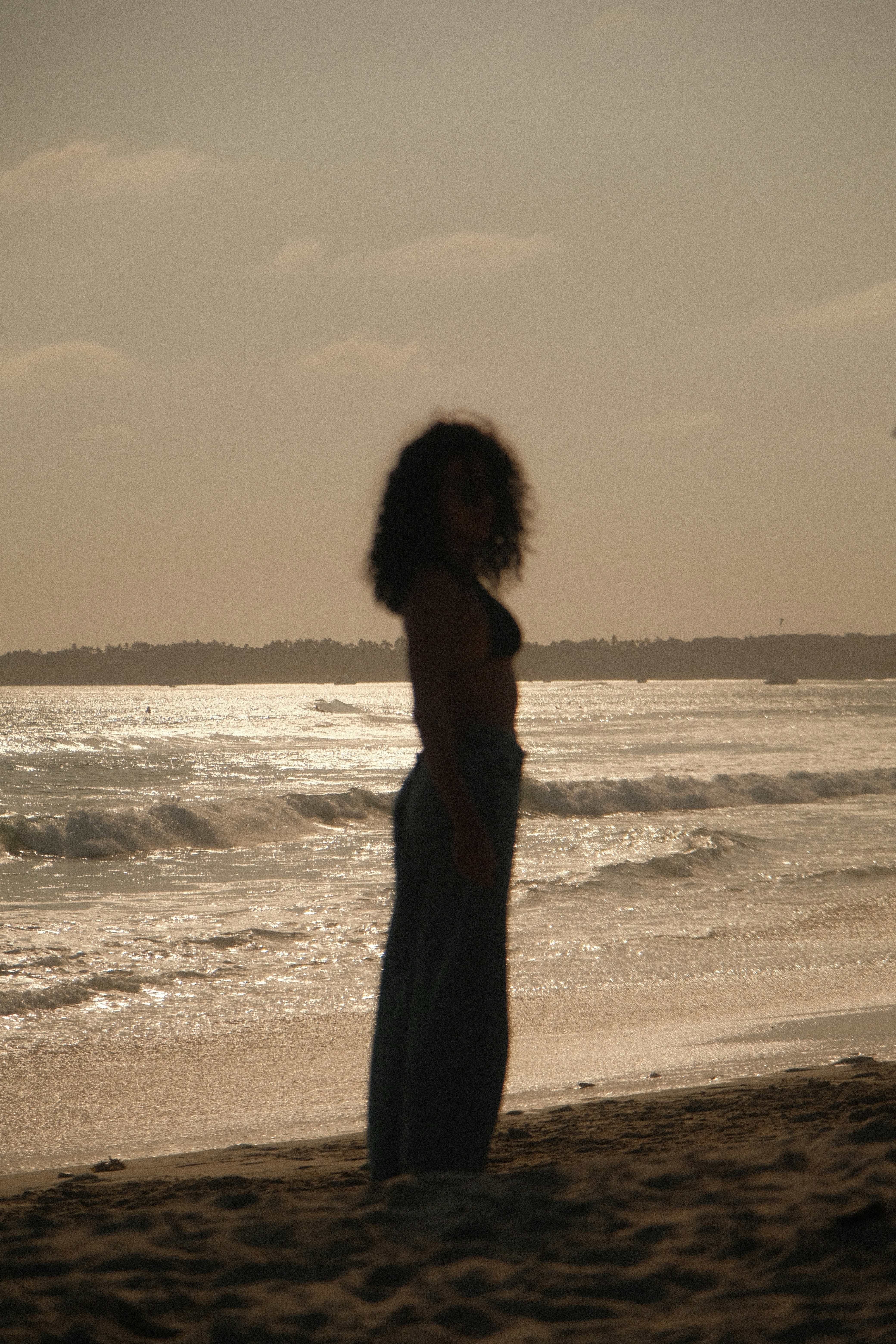 Silhouette at Sundown: A Beach Portrait in Soft Focus