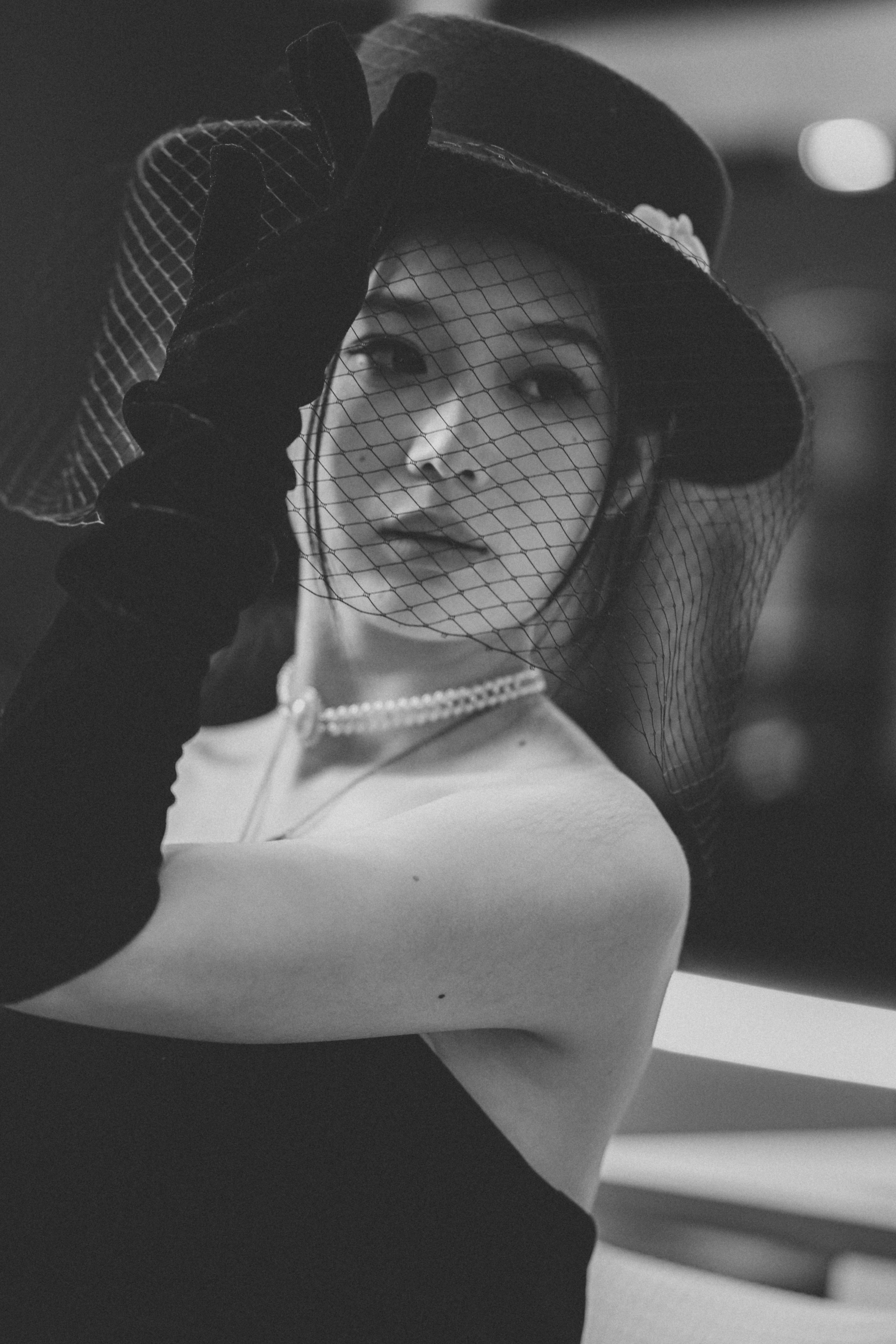 Veiled Elegance: Classic Noir Pose in a Velvet Hat