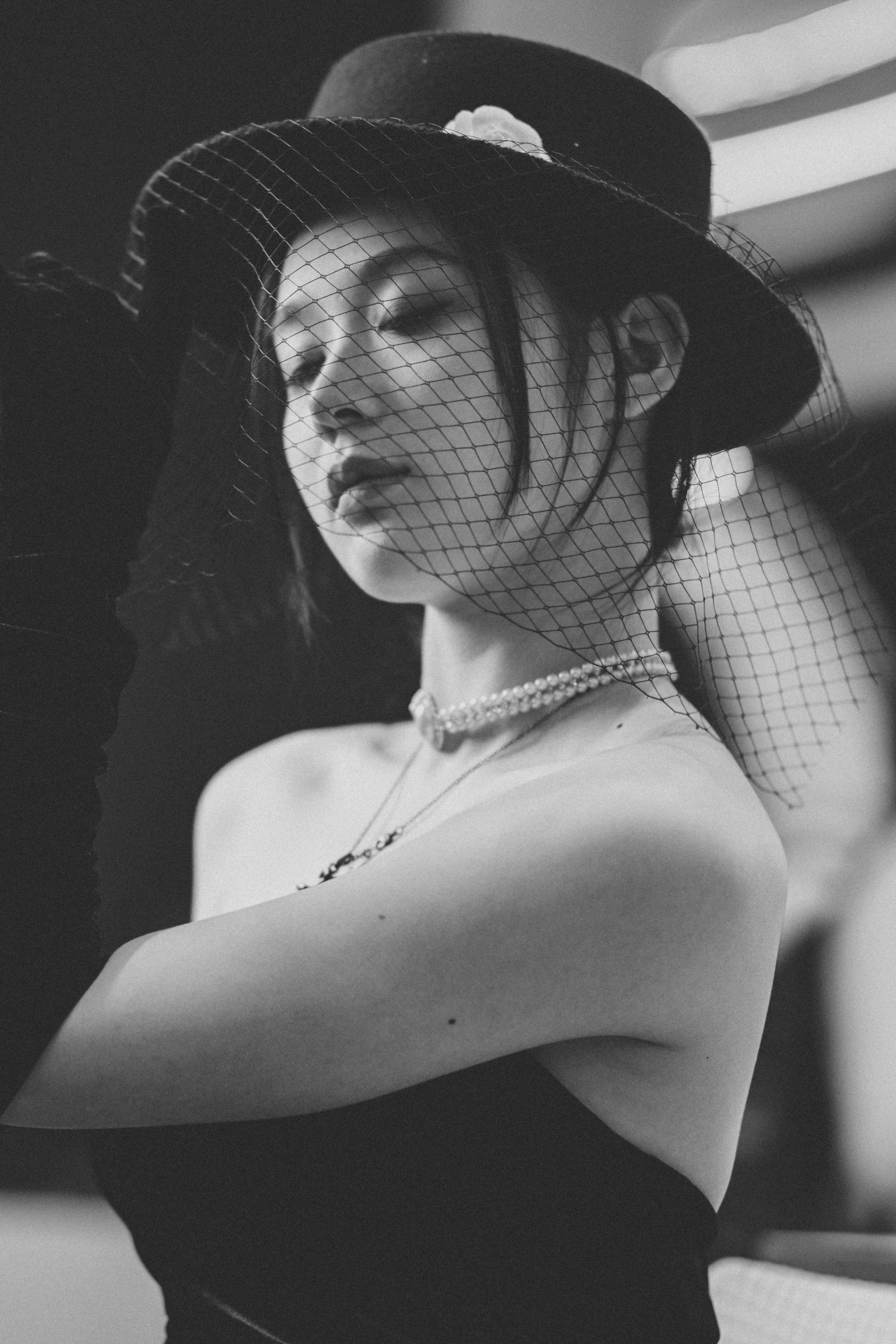 Veiled Grace: A Portrait in Noir Veil and Fedora