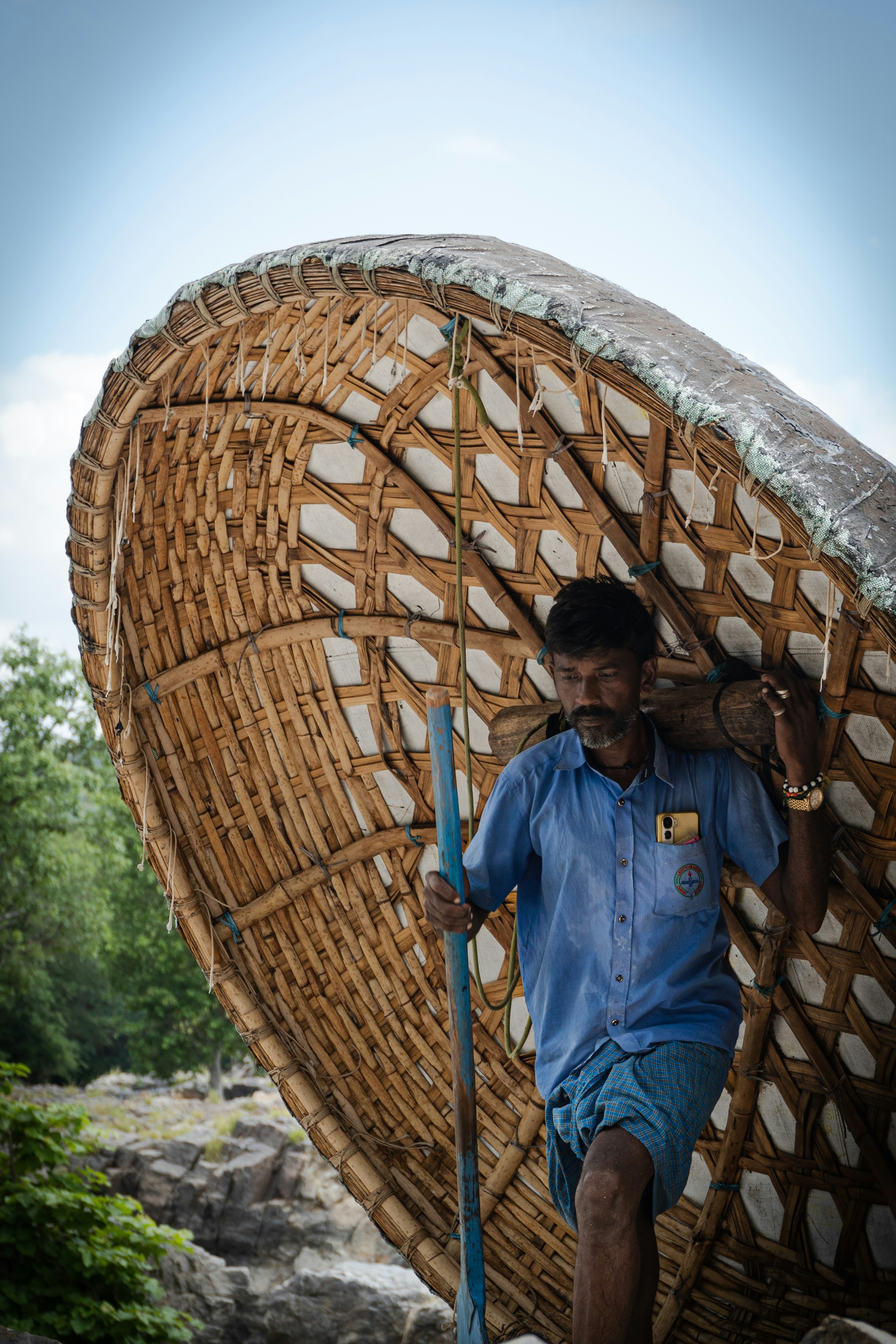 Under the Loom: A Worker Emerges from the Woven Shelter