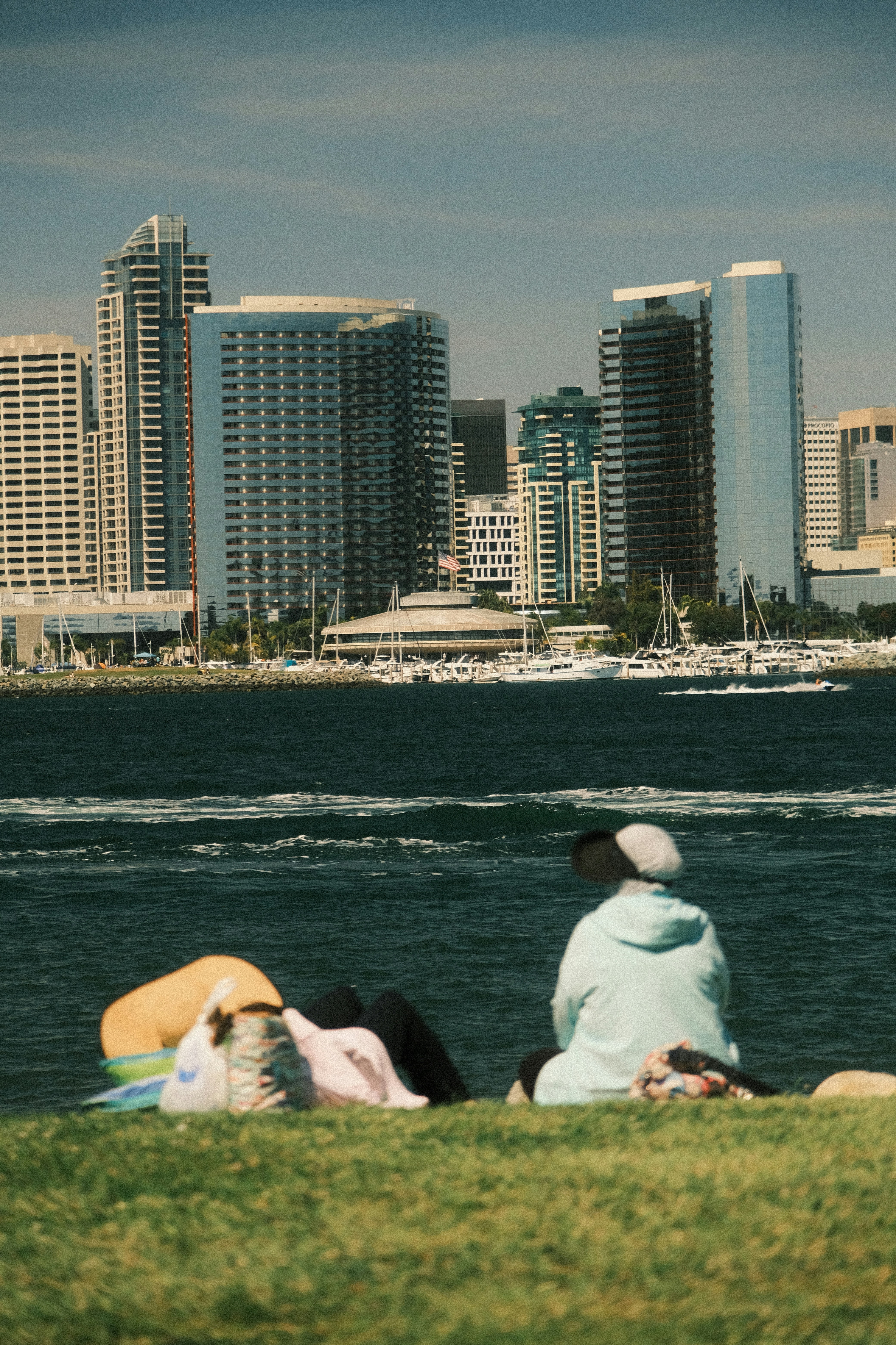 Cityscape by the Waterfront: People at Rest with Skyscrapers