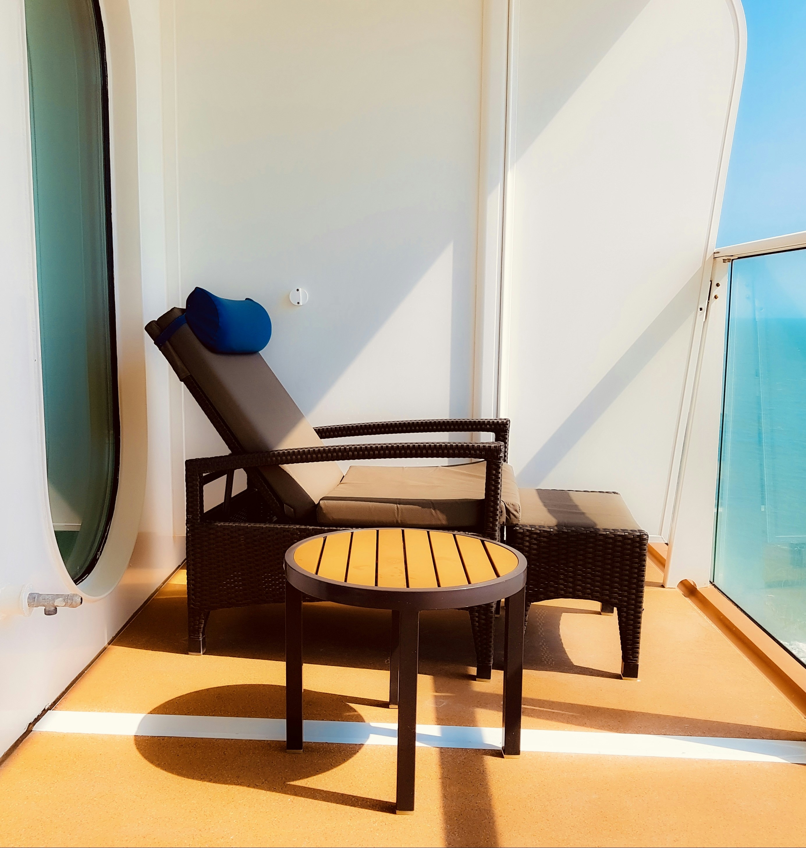 Sunny Balcony Oasis with Woven Lounge and Round Table