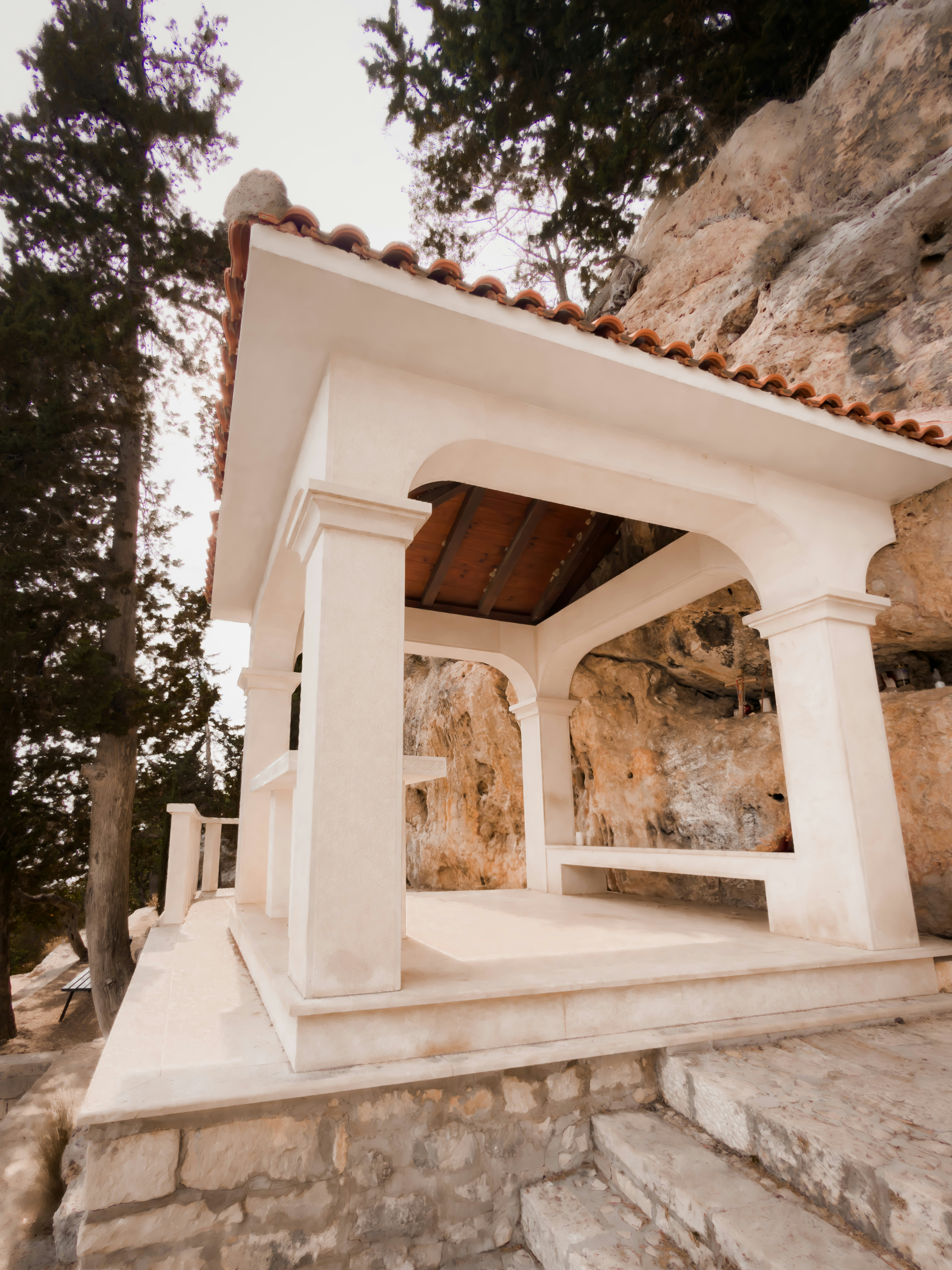 Stone Shelter Amid Cliffside Pines