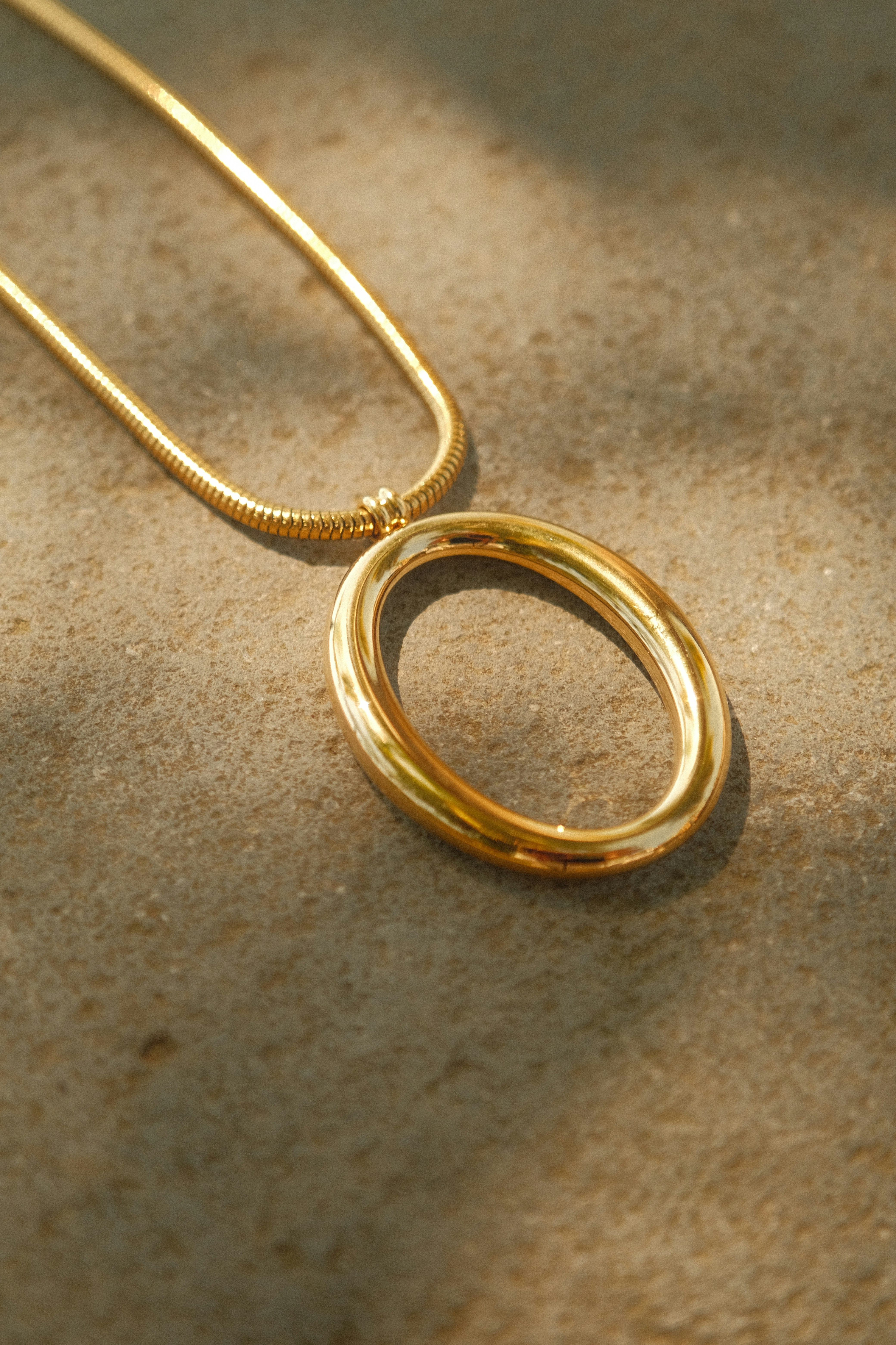 Gold Circles on Sand: A Glint of Jewelry in Sunlit Quiet