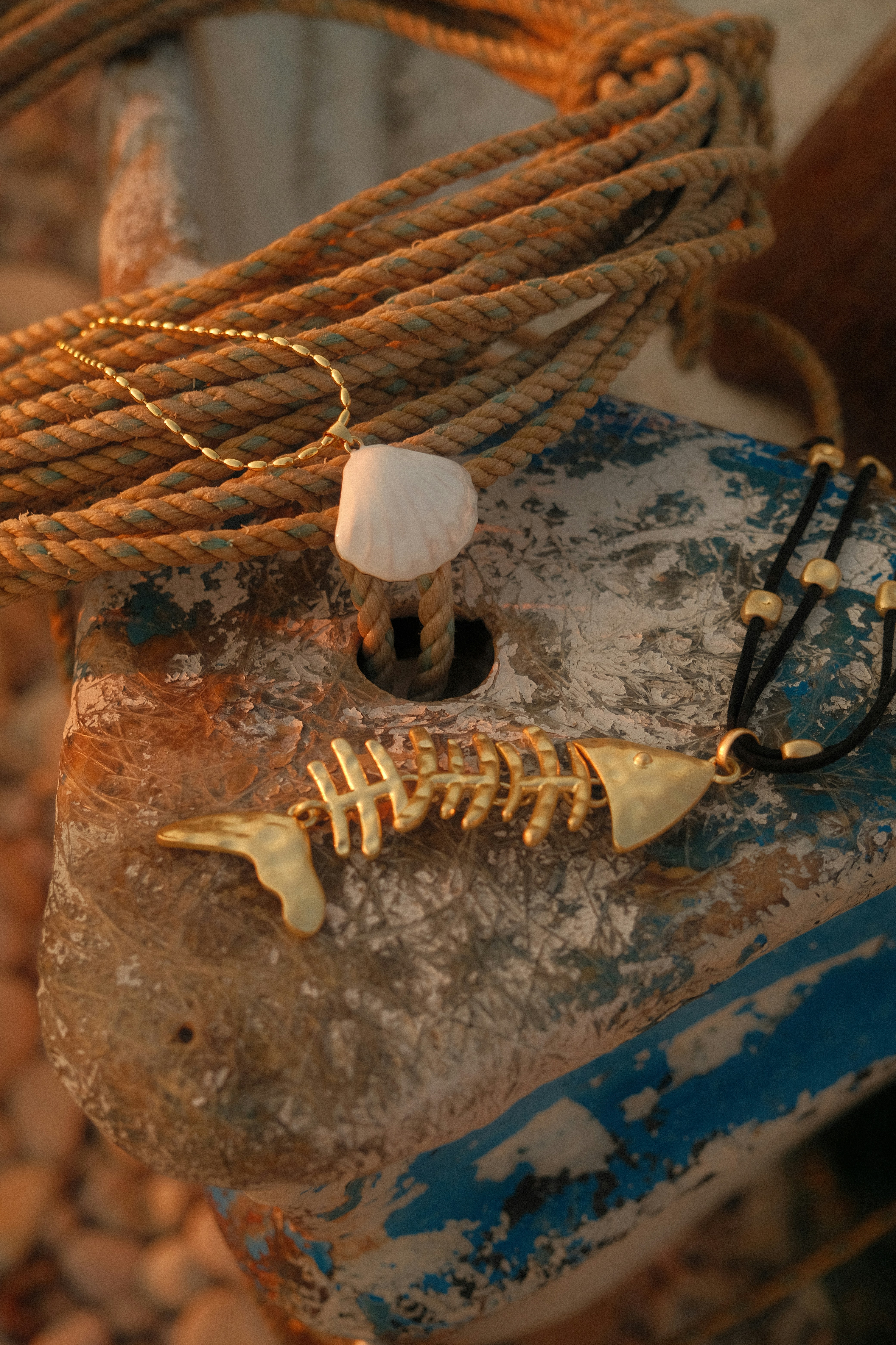 Treasured Tides: Weathered Lock and Beach Jewelry Resting on a Painted Buoy