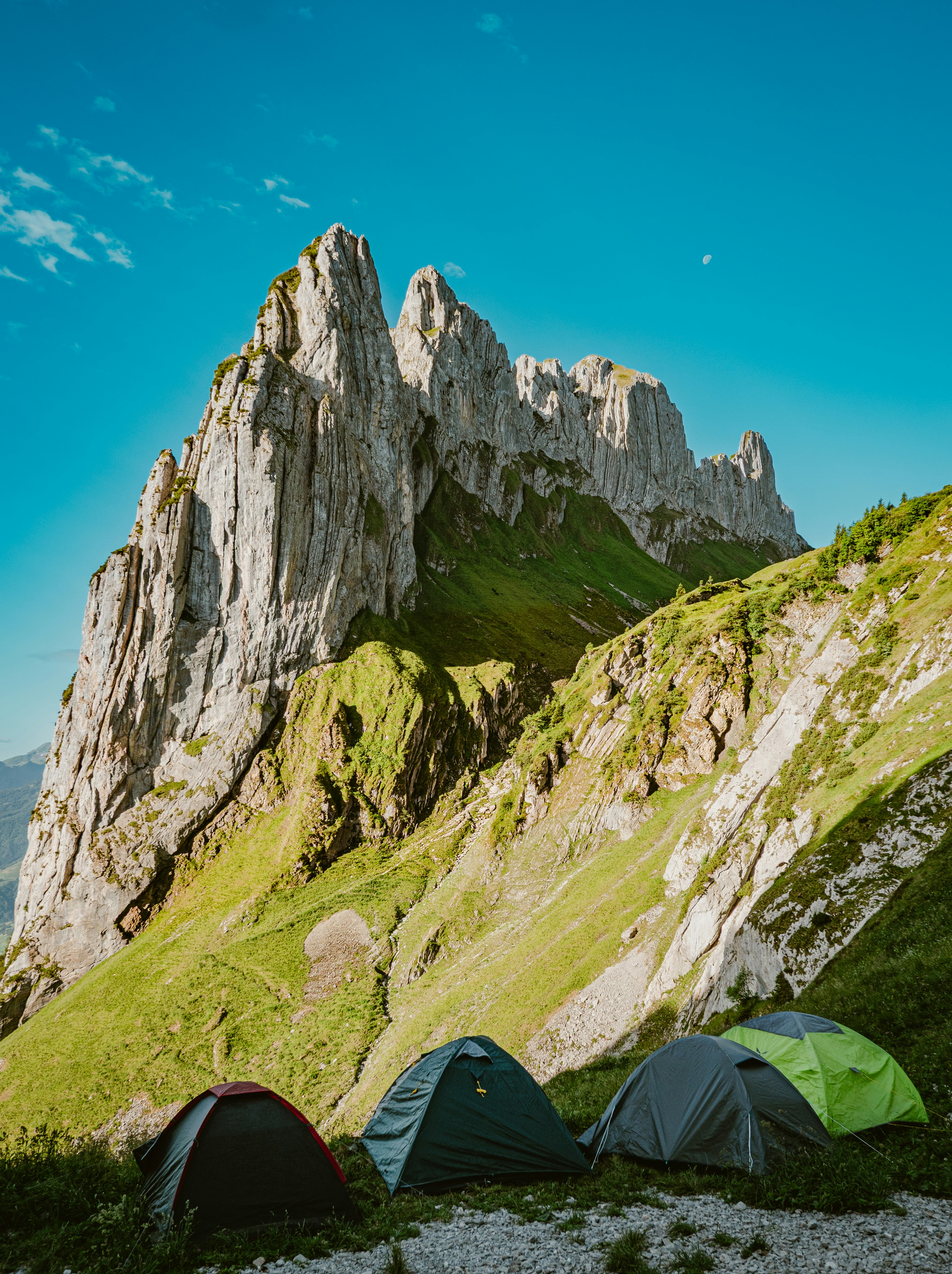 Twin Peaks Above the Campsite: Green Slopes Meet Jagged Sky
