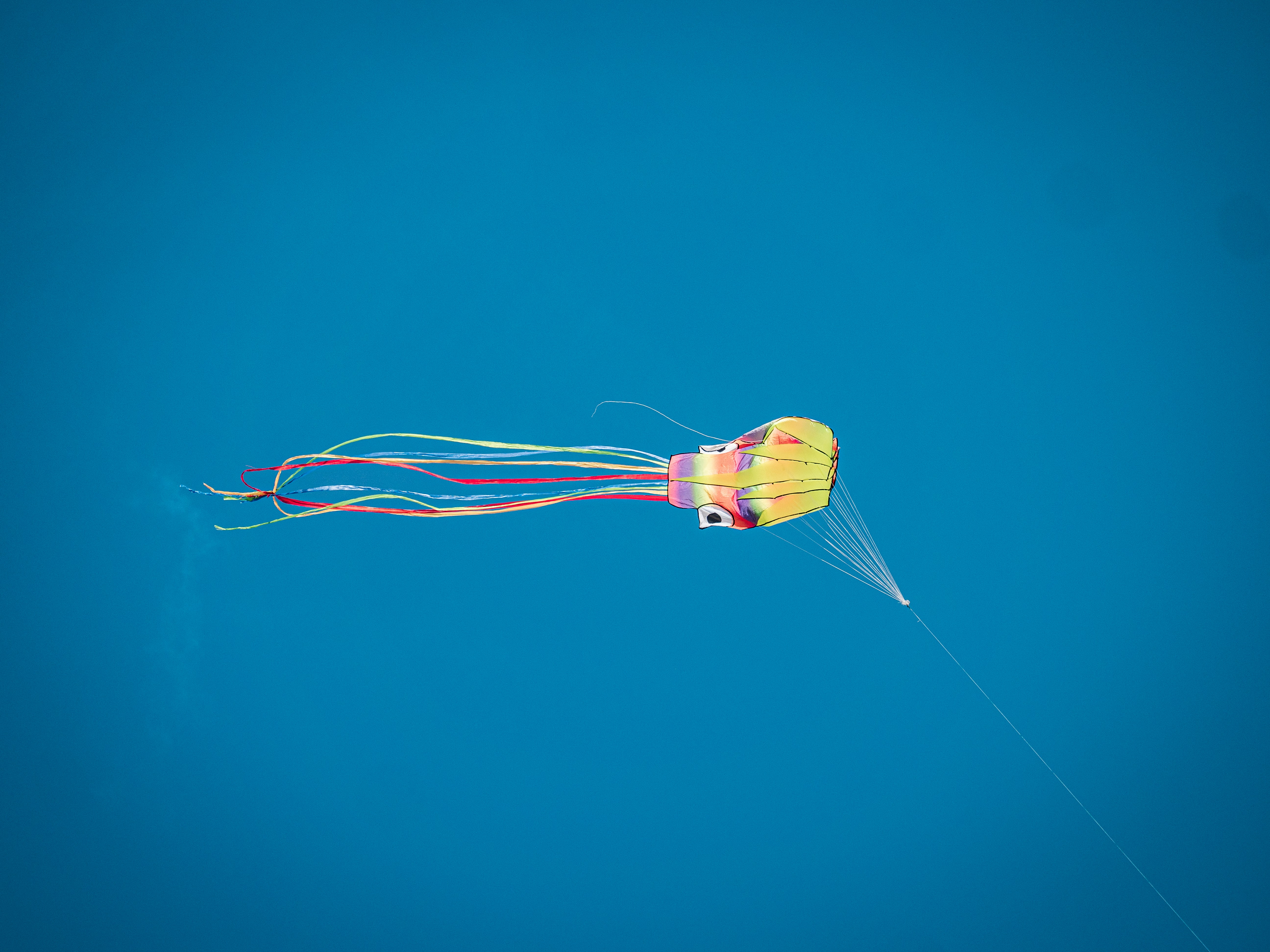 Colorful Jellyfish Kite Drifts Across a Clear Blue Sky