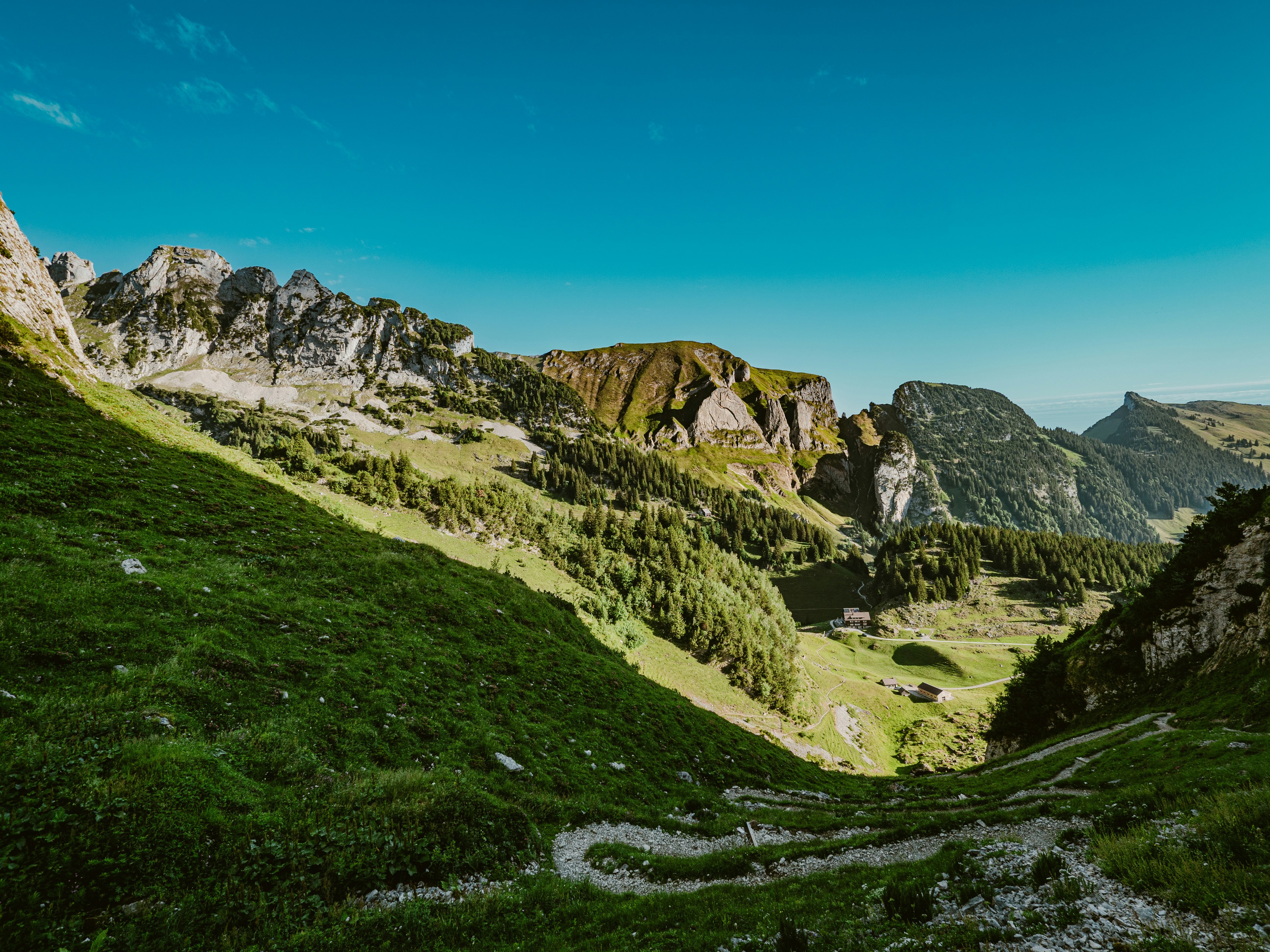 Sunlit Basin Between Craggy Ridges