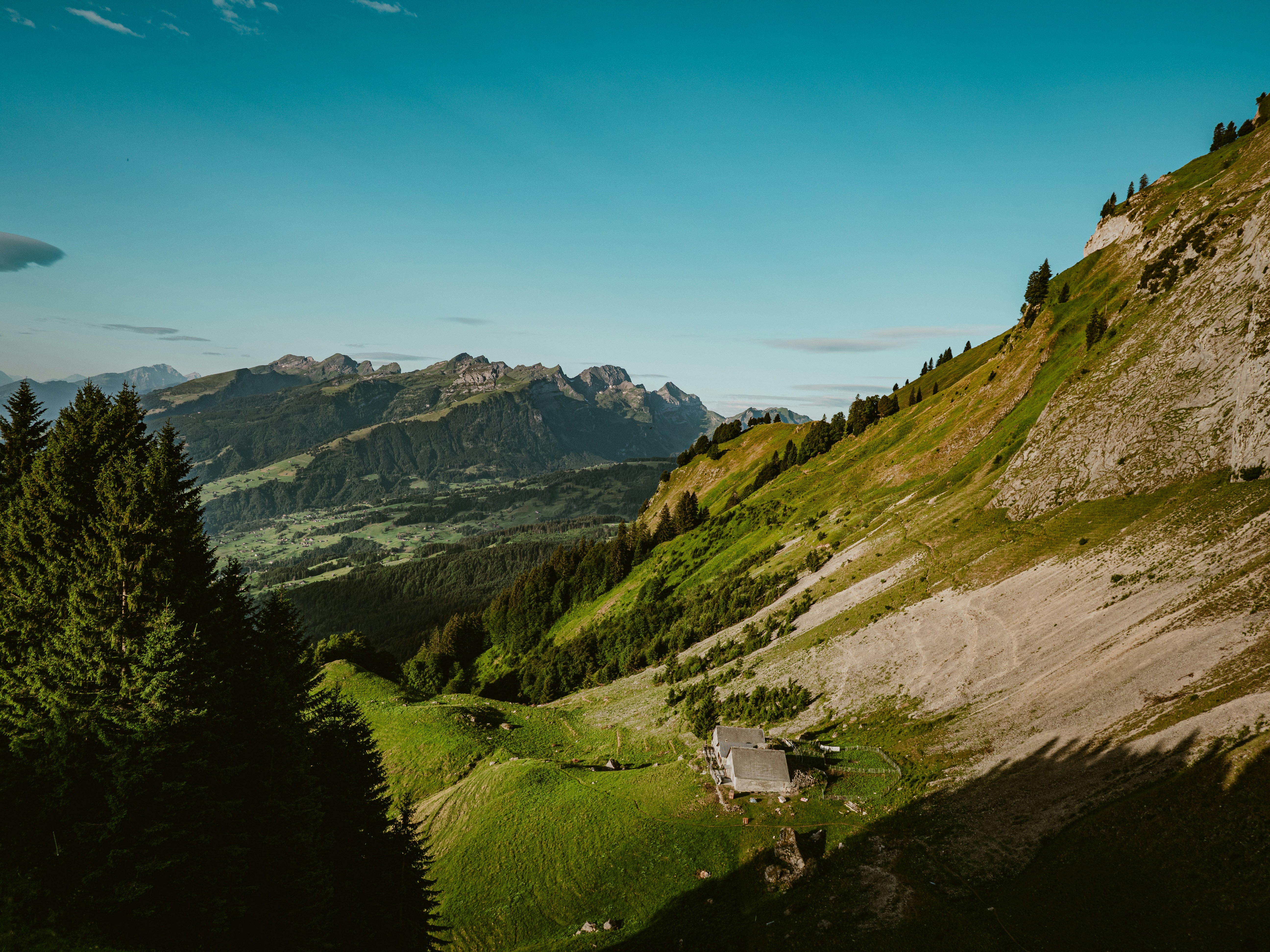 Alpine Ridge: Sunlit Slope Overlooking a Valley
