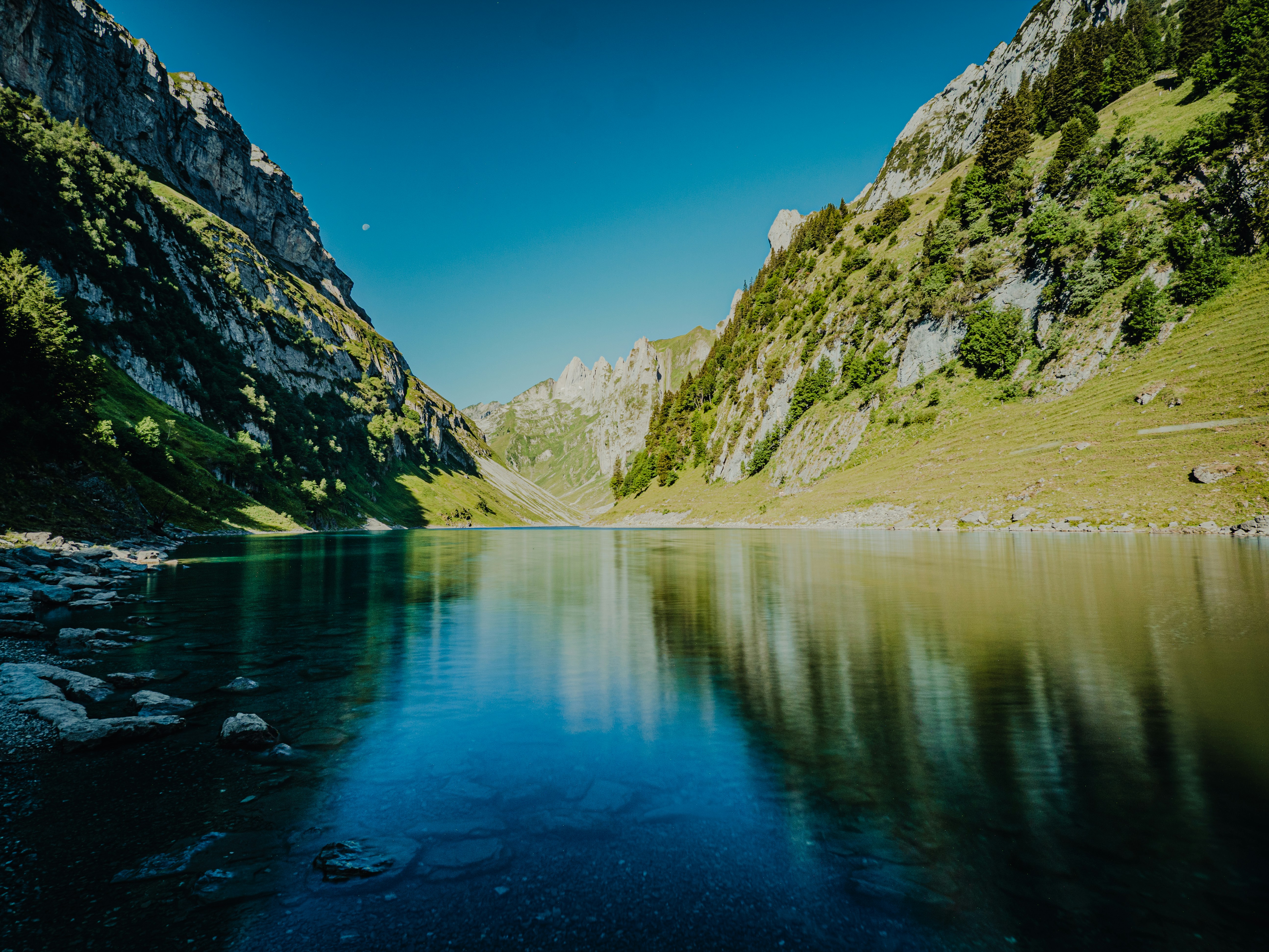 Mirror Lake in a V-shaped Valley under a Clear Alpine Sky