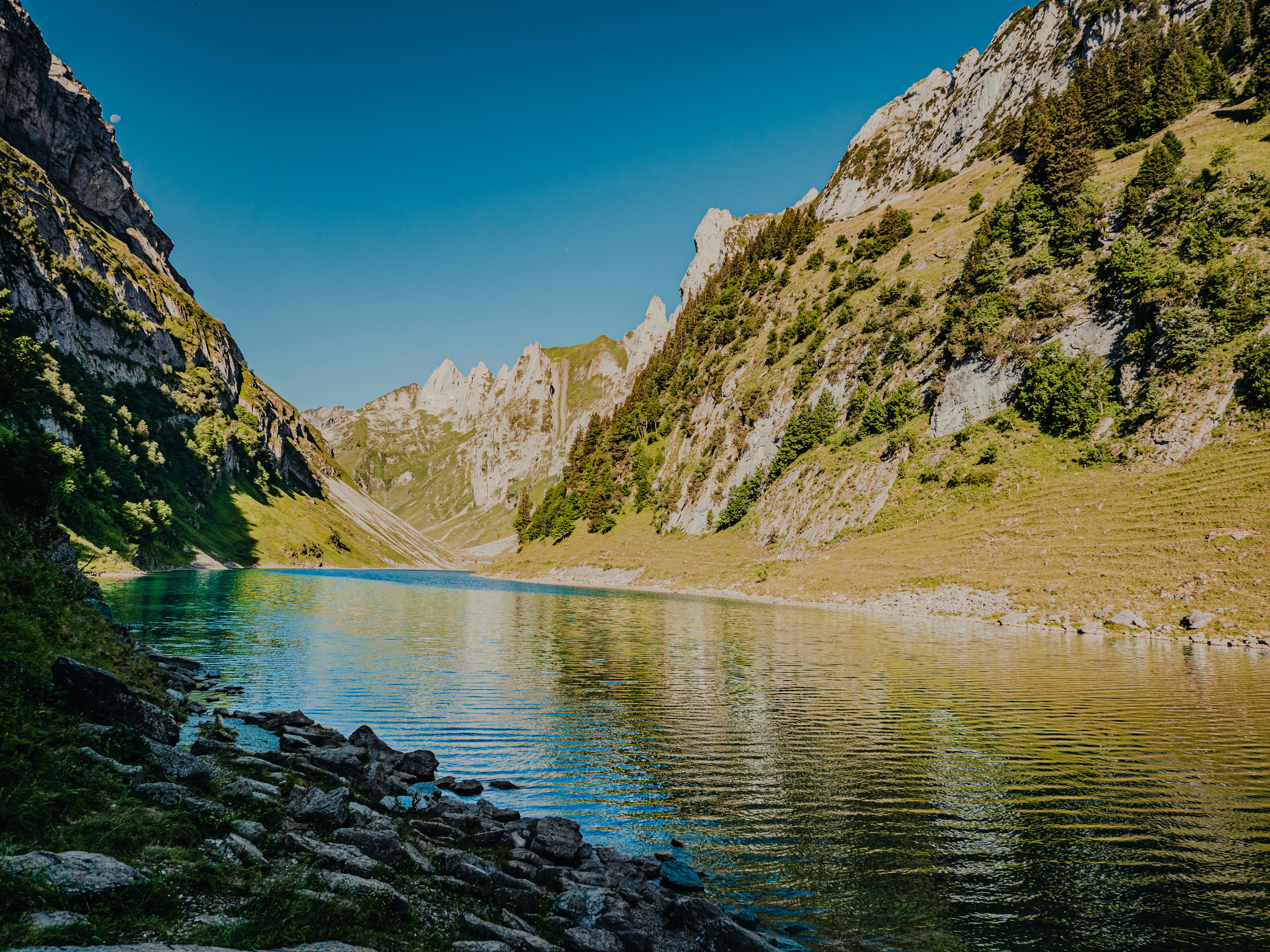 Glacial Mirror: A Lake Cradled Between Mountain Rangs