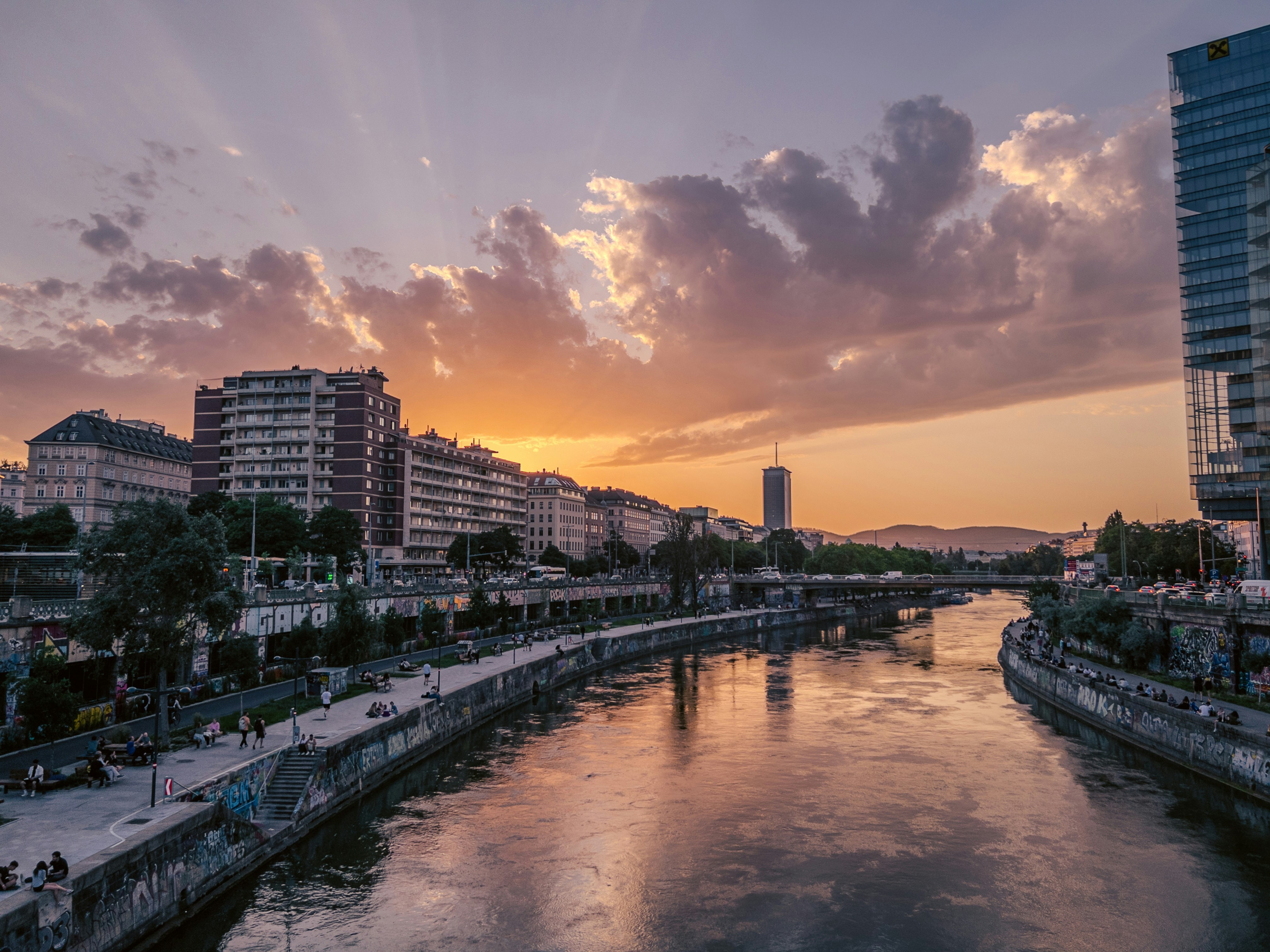 Sunset Over the Arno-esque Channel: Riverside Skyline in Warm Hues