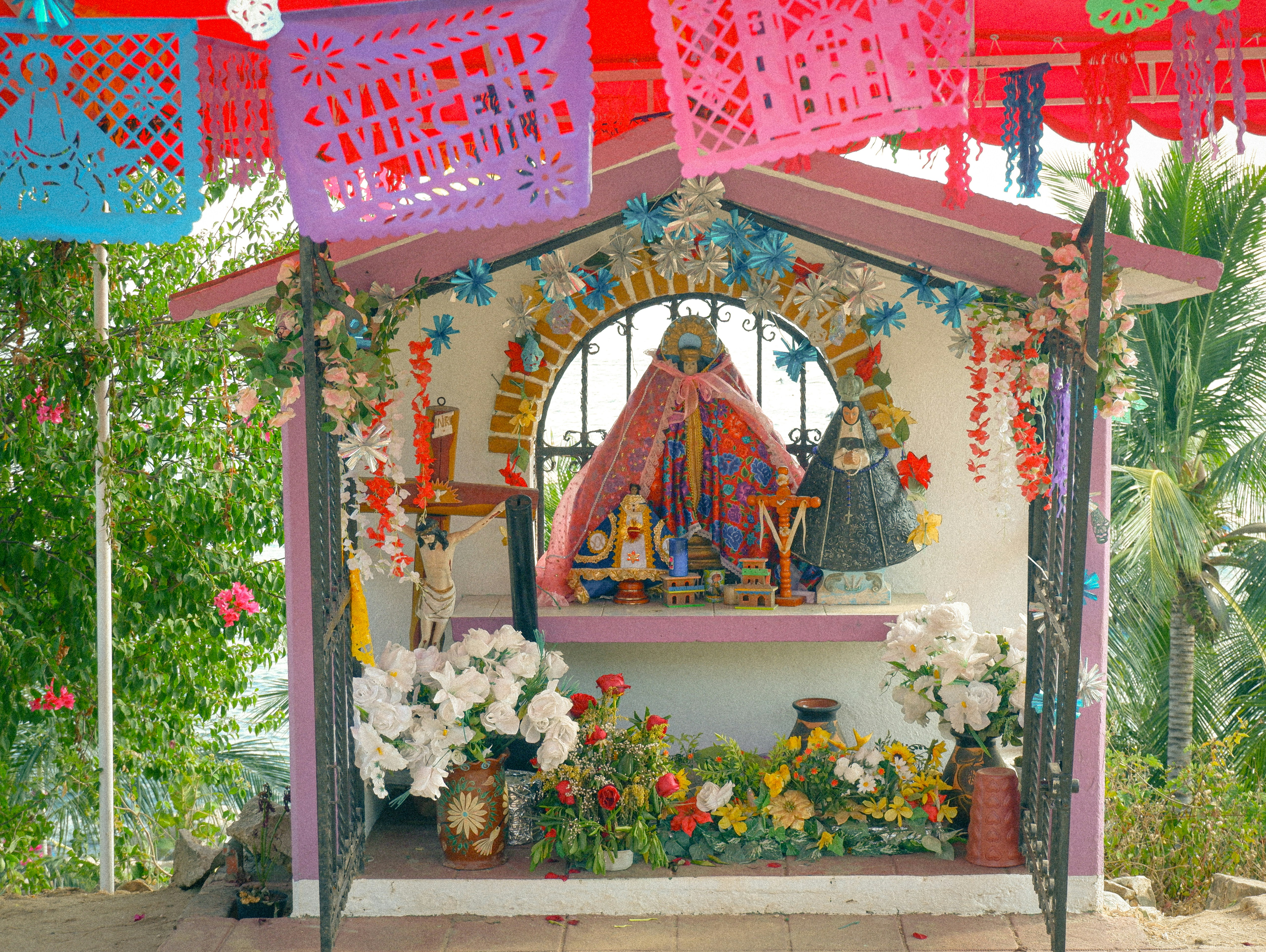Vivid Shrine Altar Framed by Colorful Papel Picado