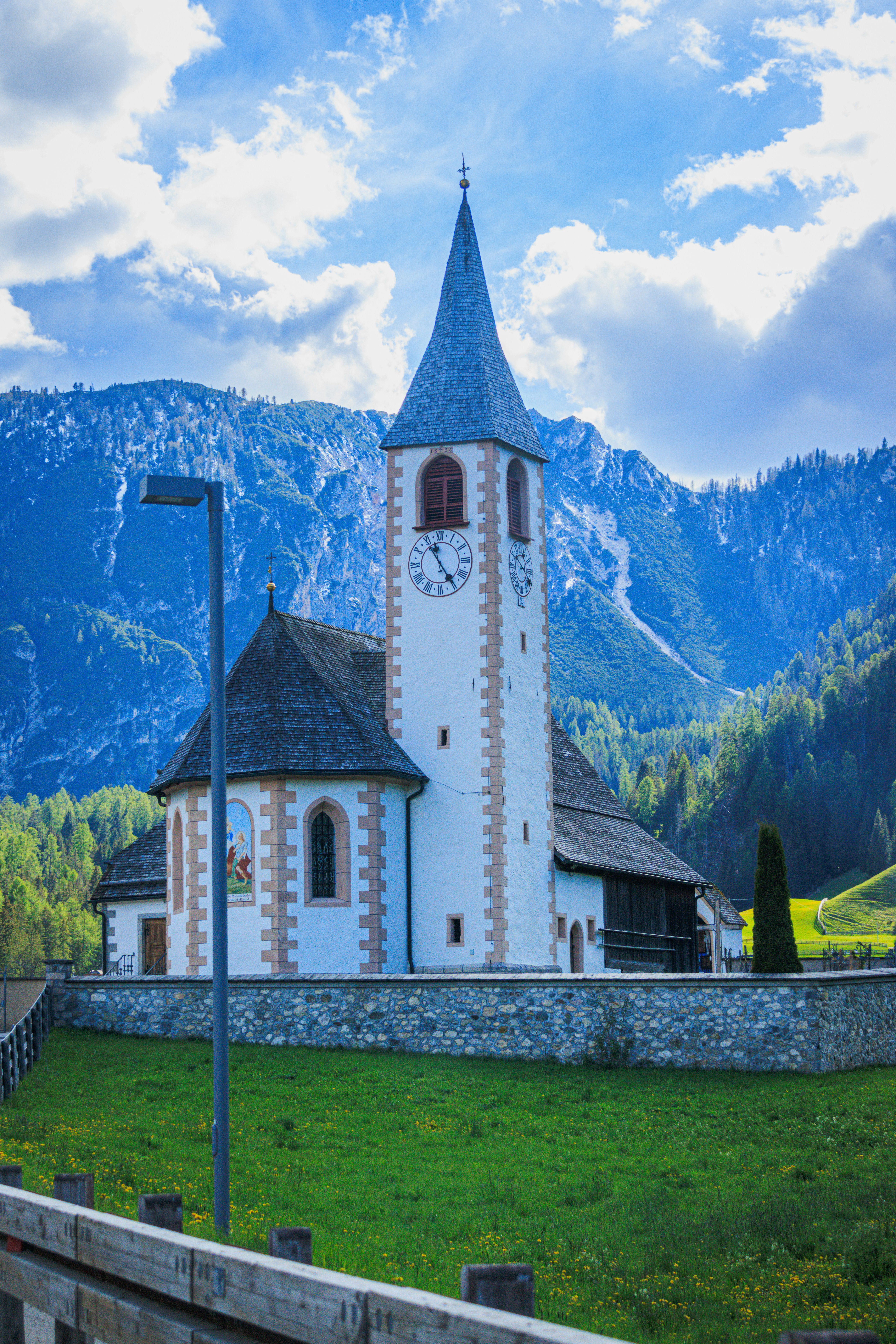 Clocktower in Alpine Chapel Under a Blue Sky