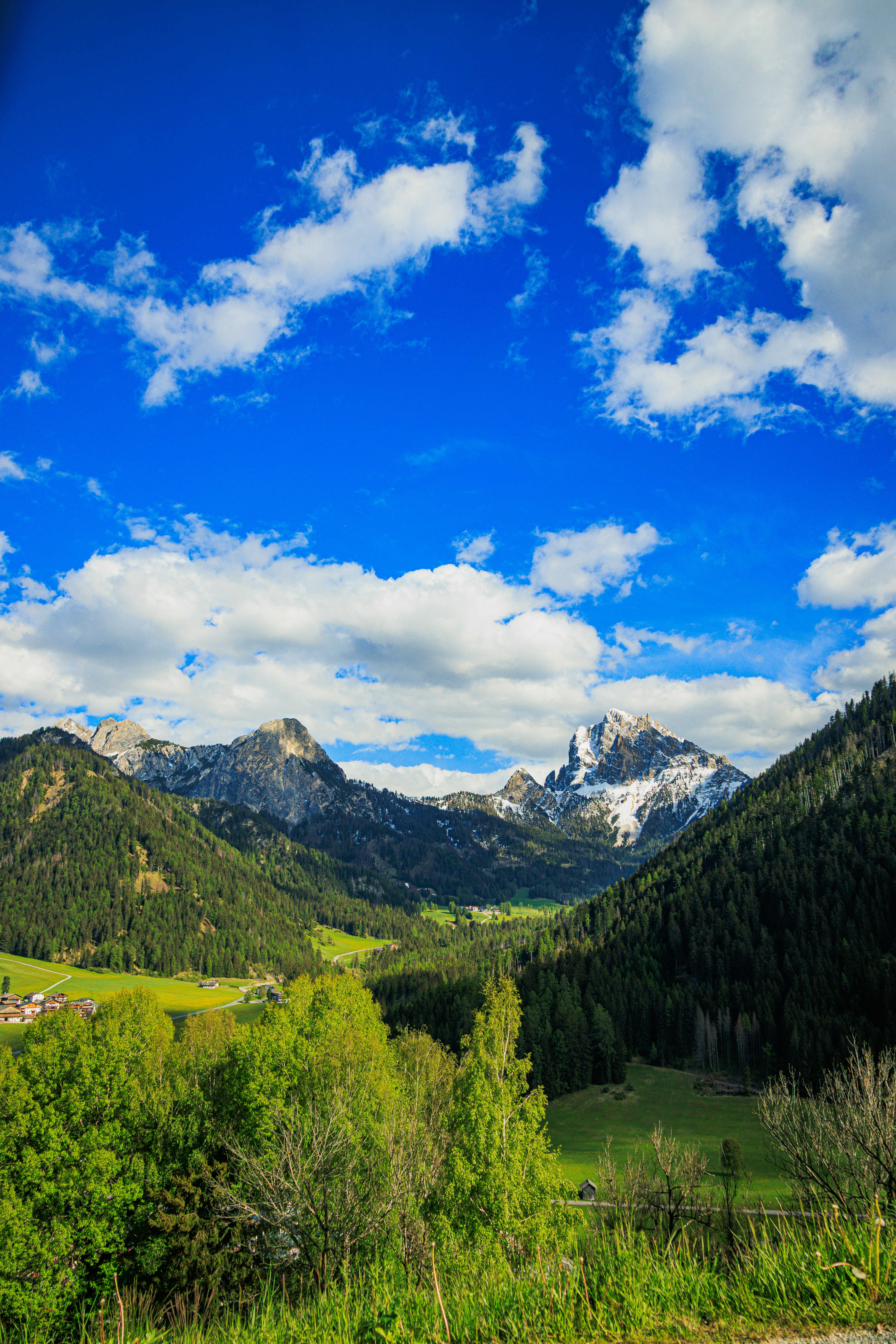 Sunlit Alpine Panorama: Peaks, Valleys, and a Velvet Sky