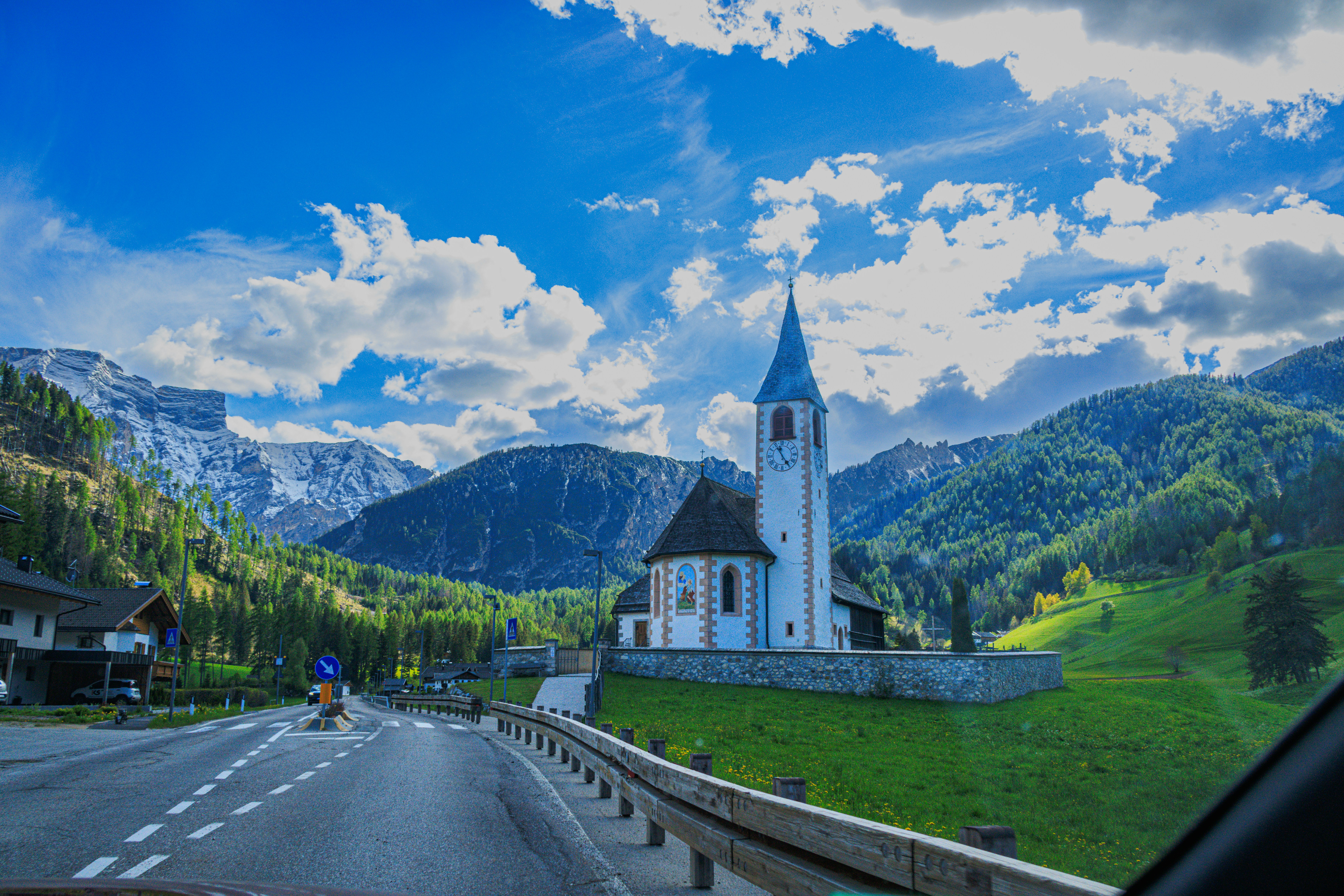Chapel on the Pass: A Alpine Road Framed by Blue Sky