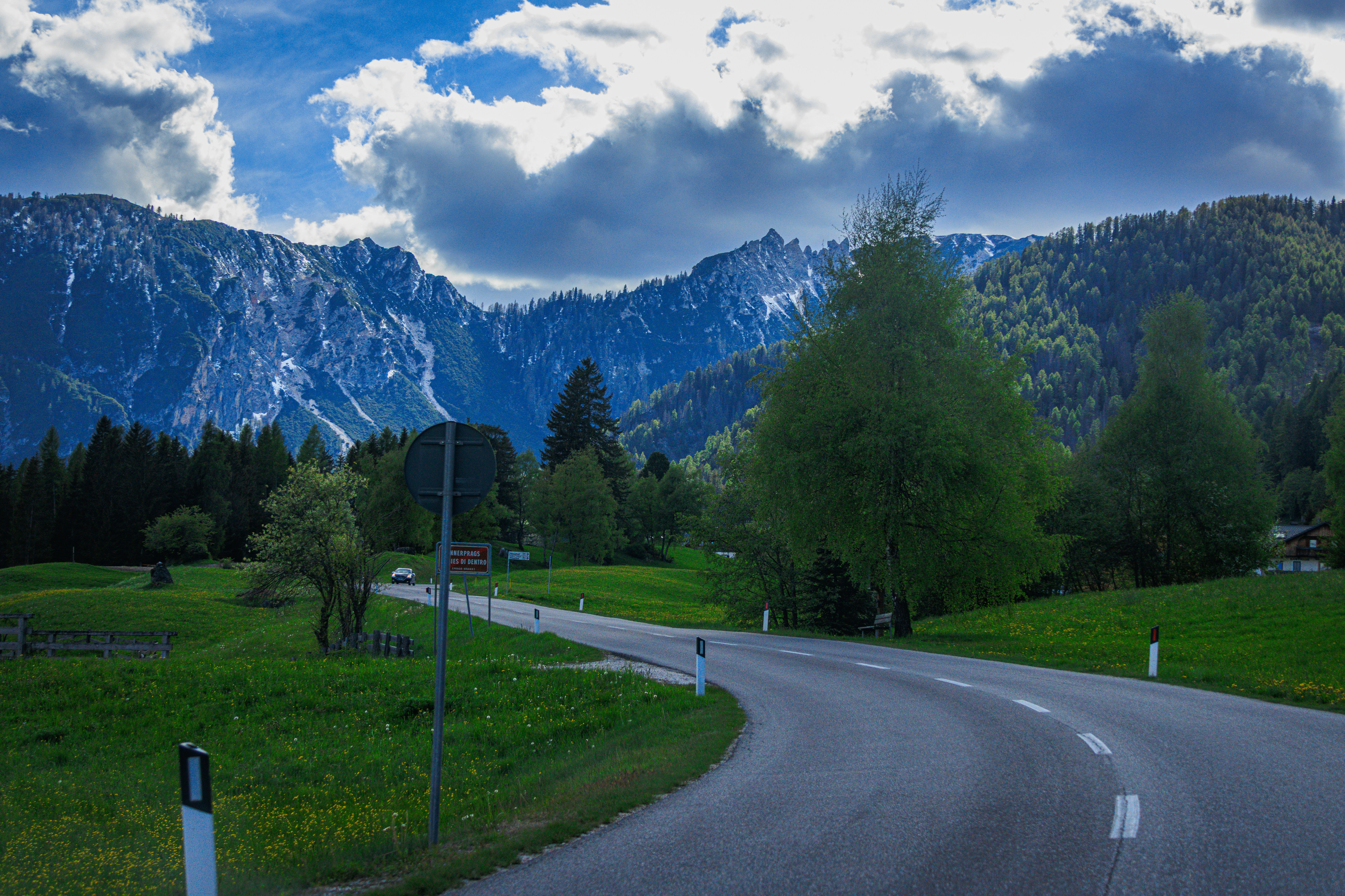 Winding Alpine Road Beneath Lofty Peaks
