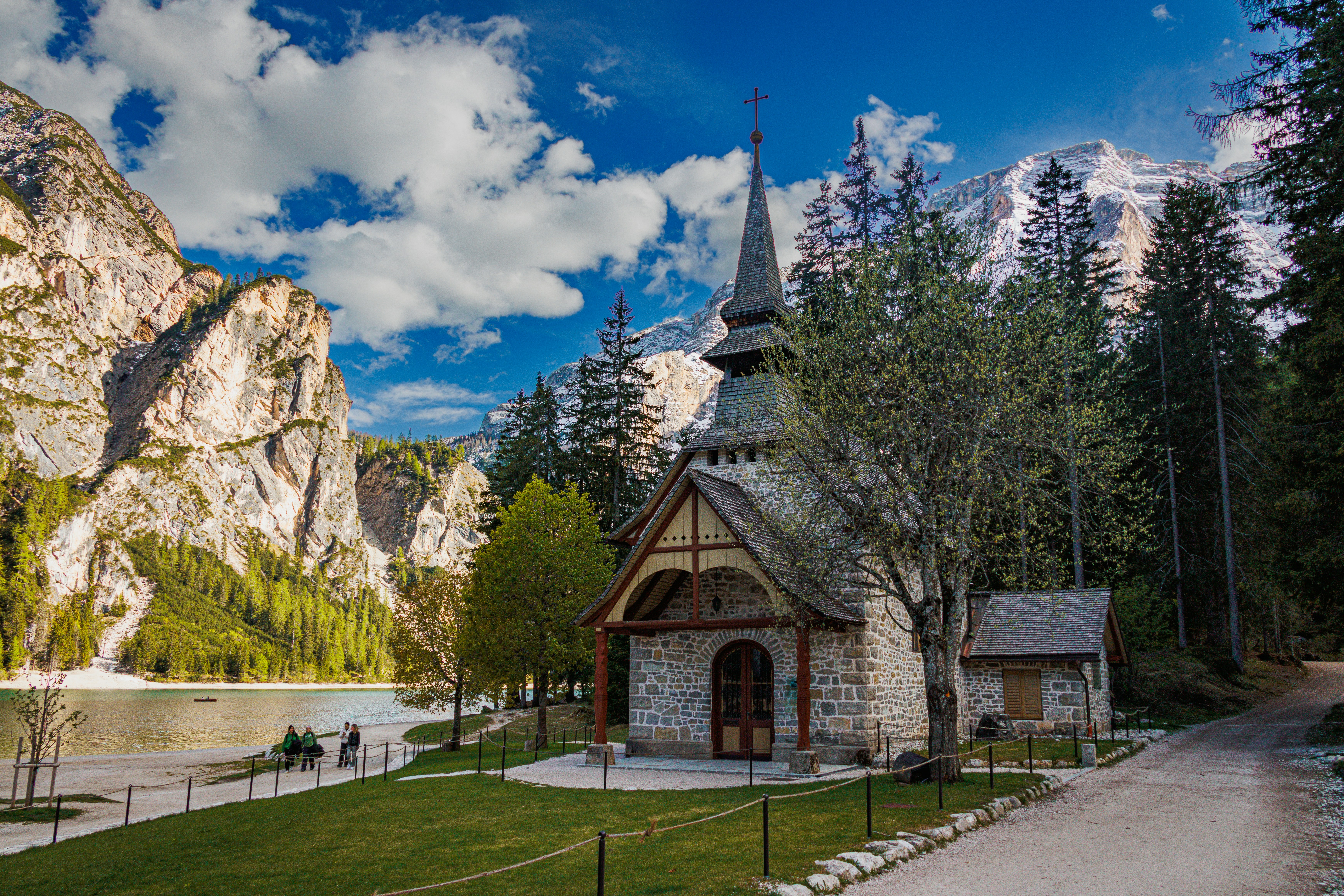 A Serene Alpine Chapel Nestled by Lake and Pines