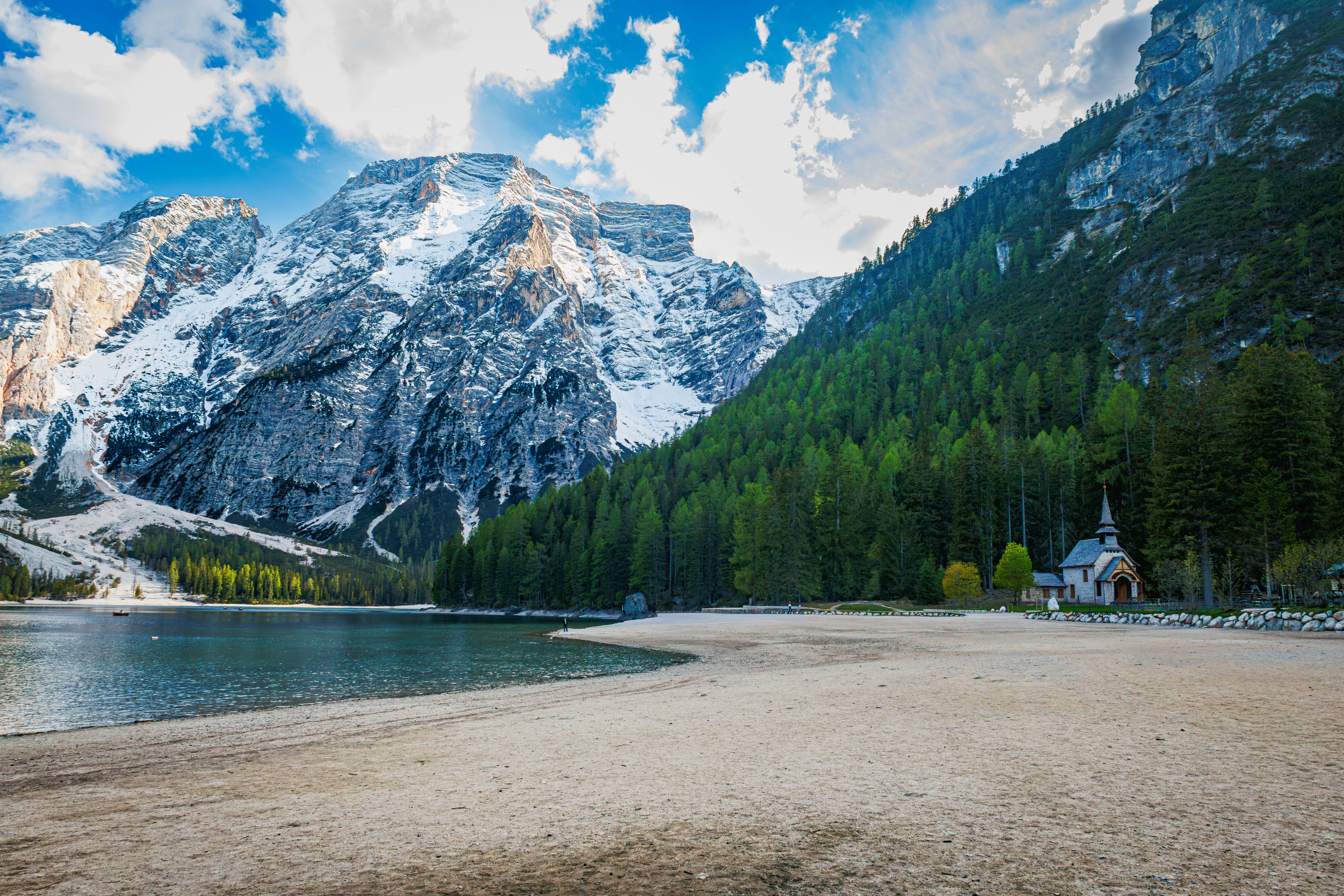 Snow-capped Peaks Meet a Serene Lakeside Chapel