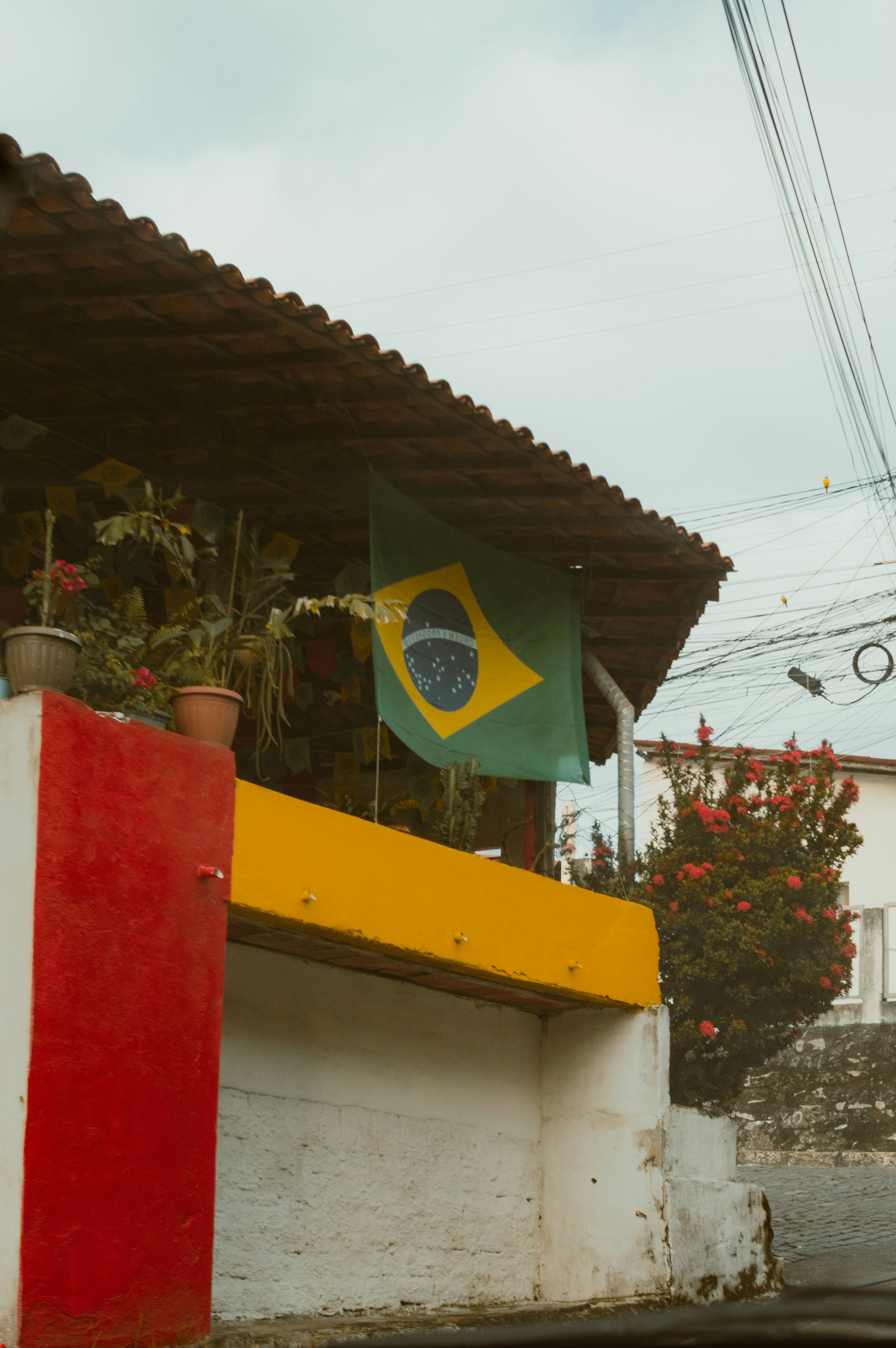 Brazilian flag on a house with red and yellow walls.