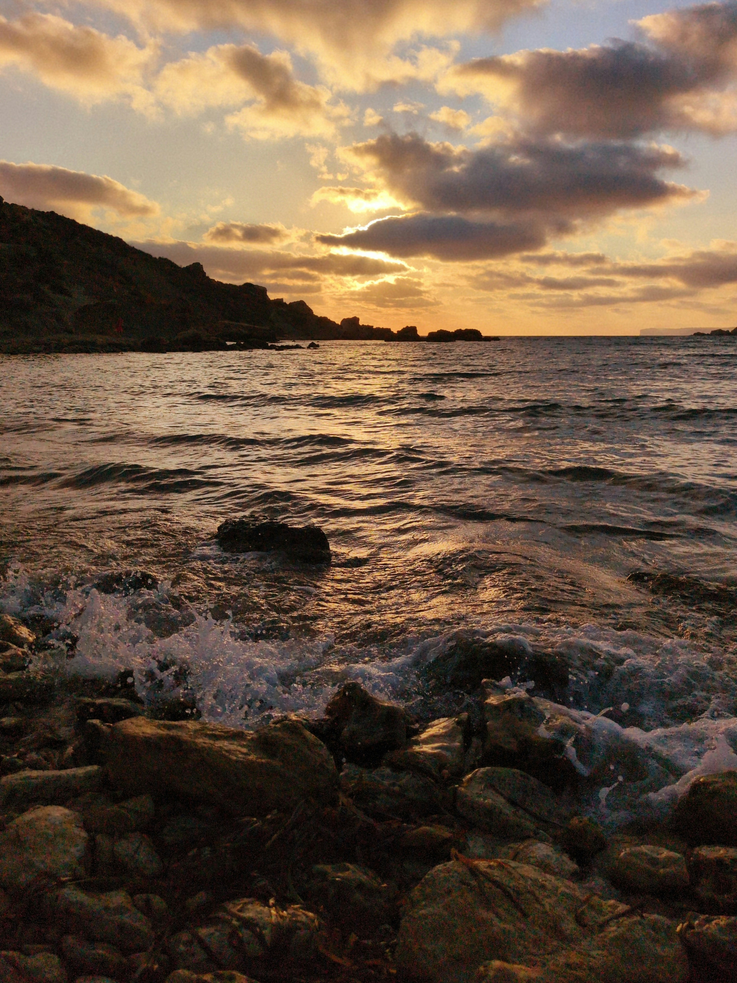 Sunset Breakers Over a Rocky Promontory
