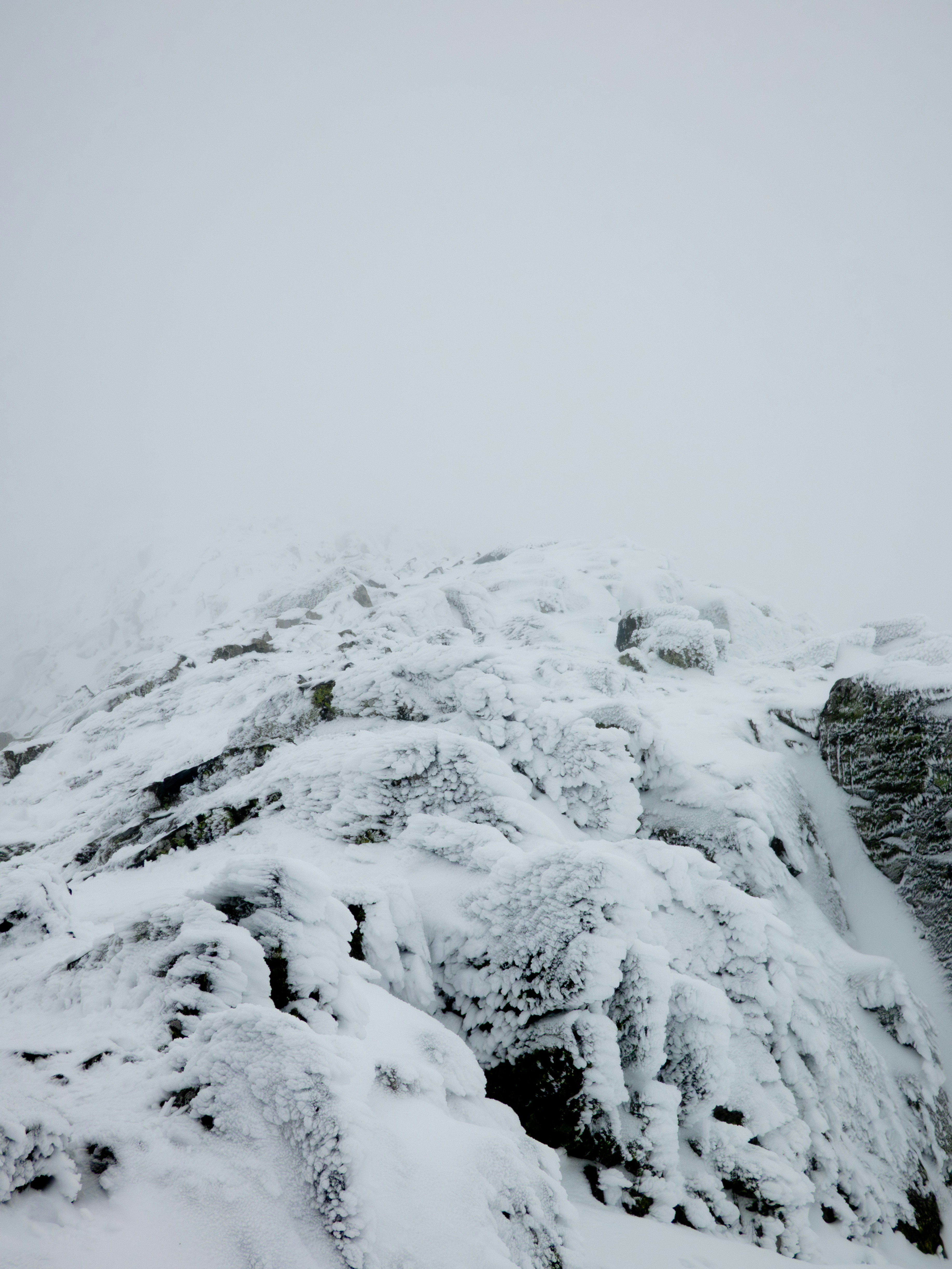 Snow-blanketed Ridge Surrounded by Mist