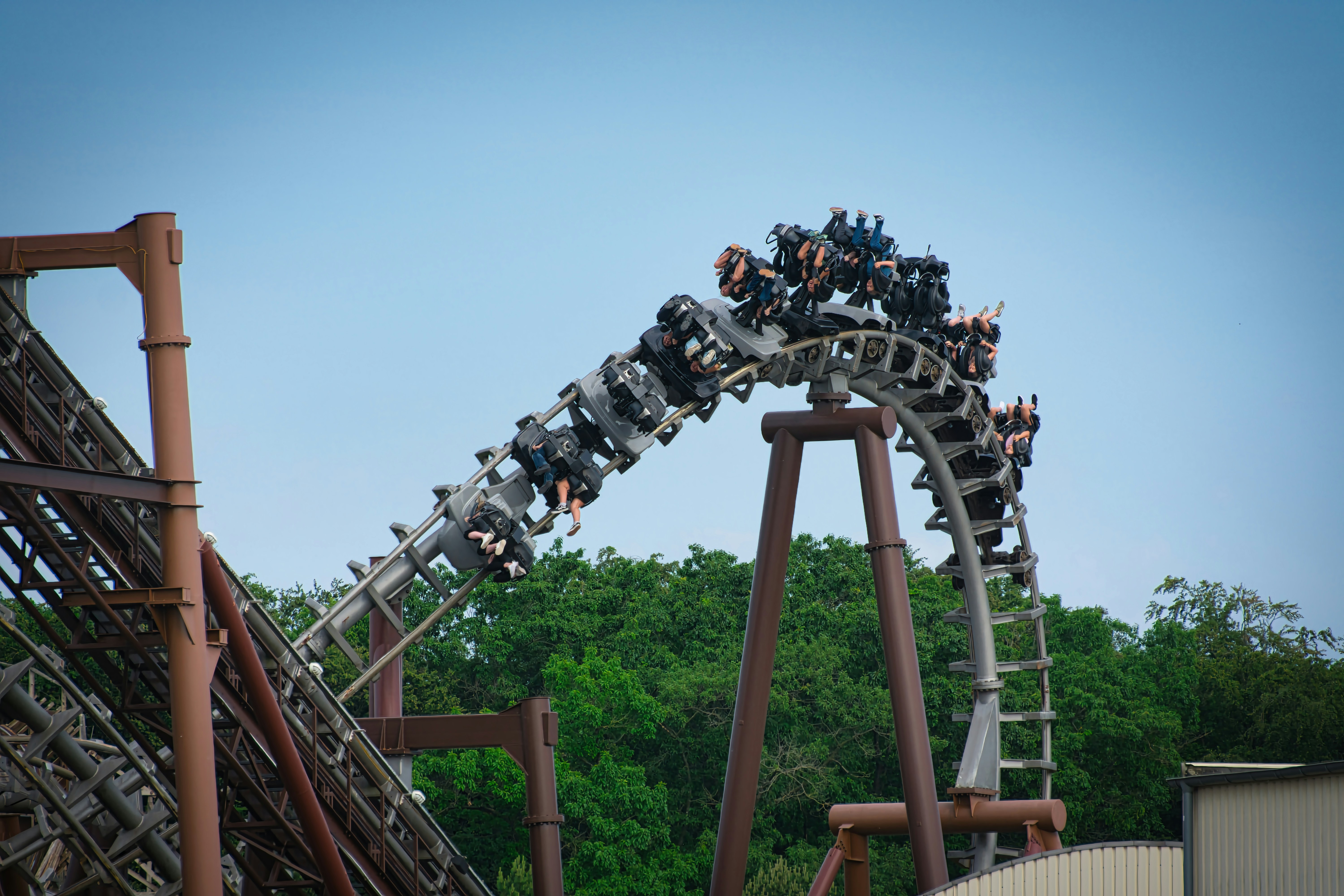 Looping Thrill: Riders Crest the Roller Coaster Arc