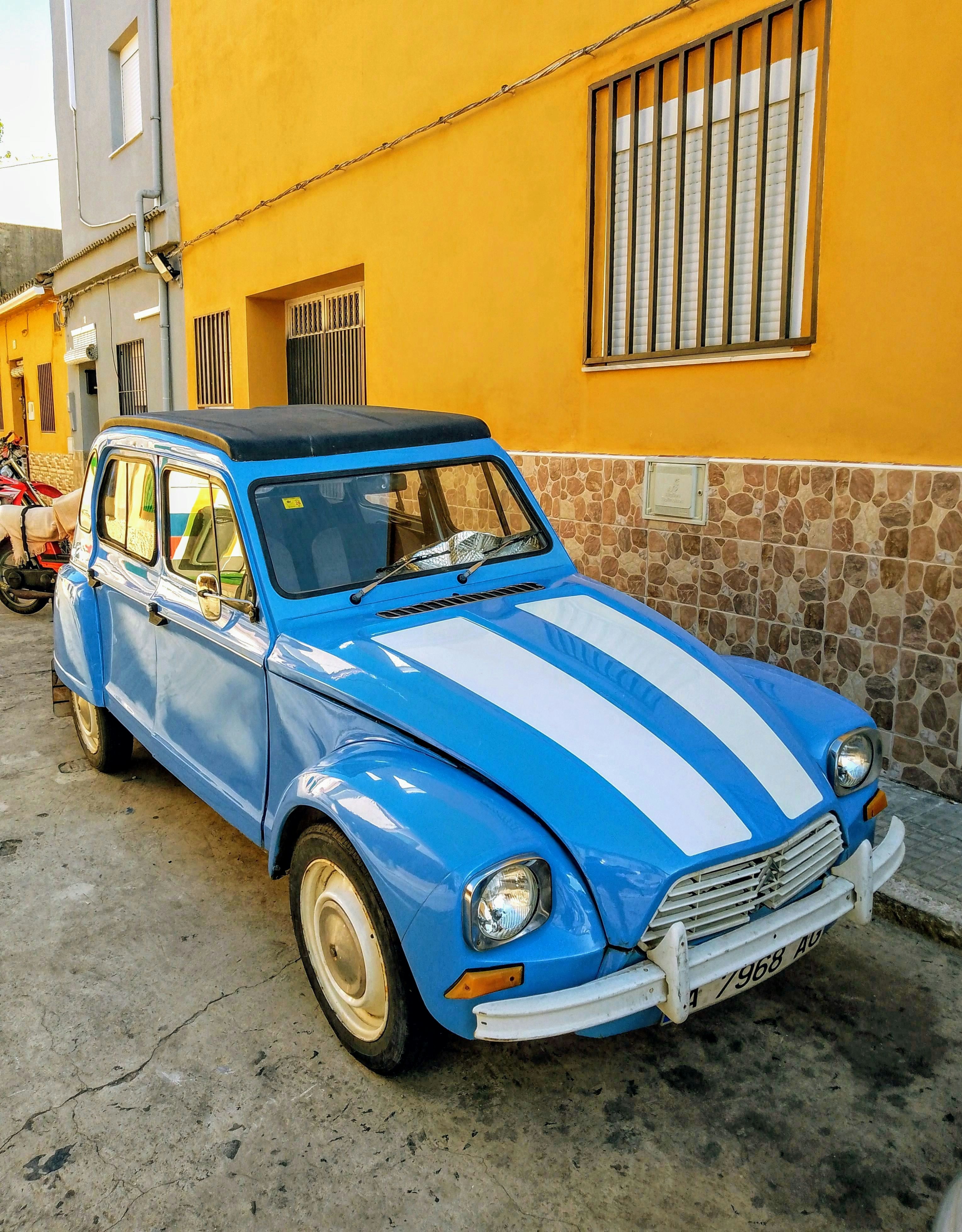 Havana vibes, old Citroen parked on the side of ancient road in a Spanish historical pueblo. Beautiful vintage vehicle, remembering better days and dreaming of more good ones.