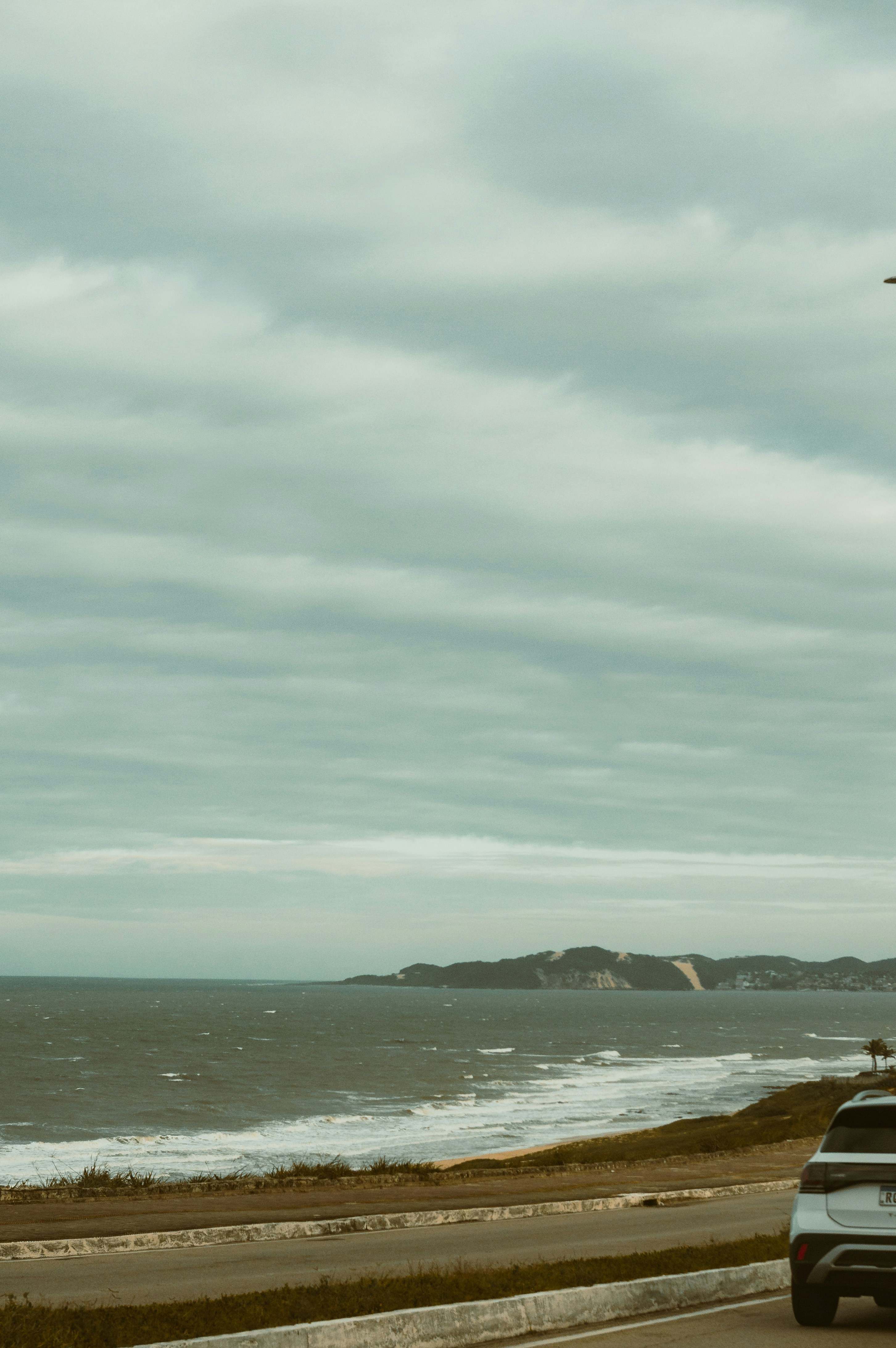 Coastal Roadride: Car at the Edge of a Quiet Horizon