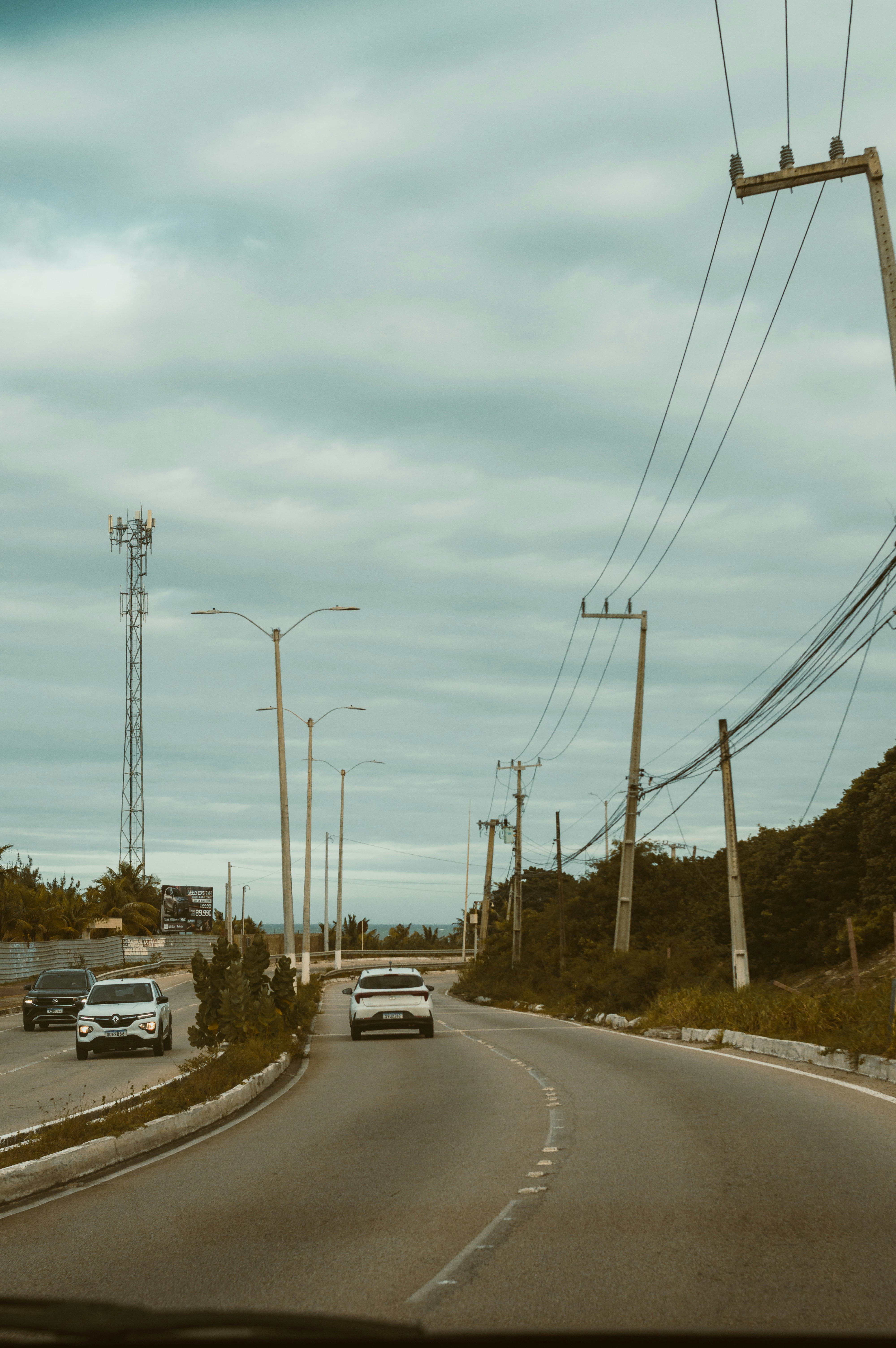 Midday Highway: Cars Ahead on a Quiet Coastal Route