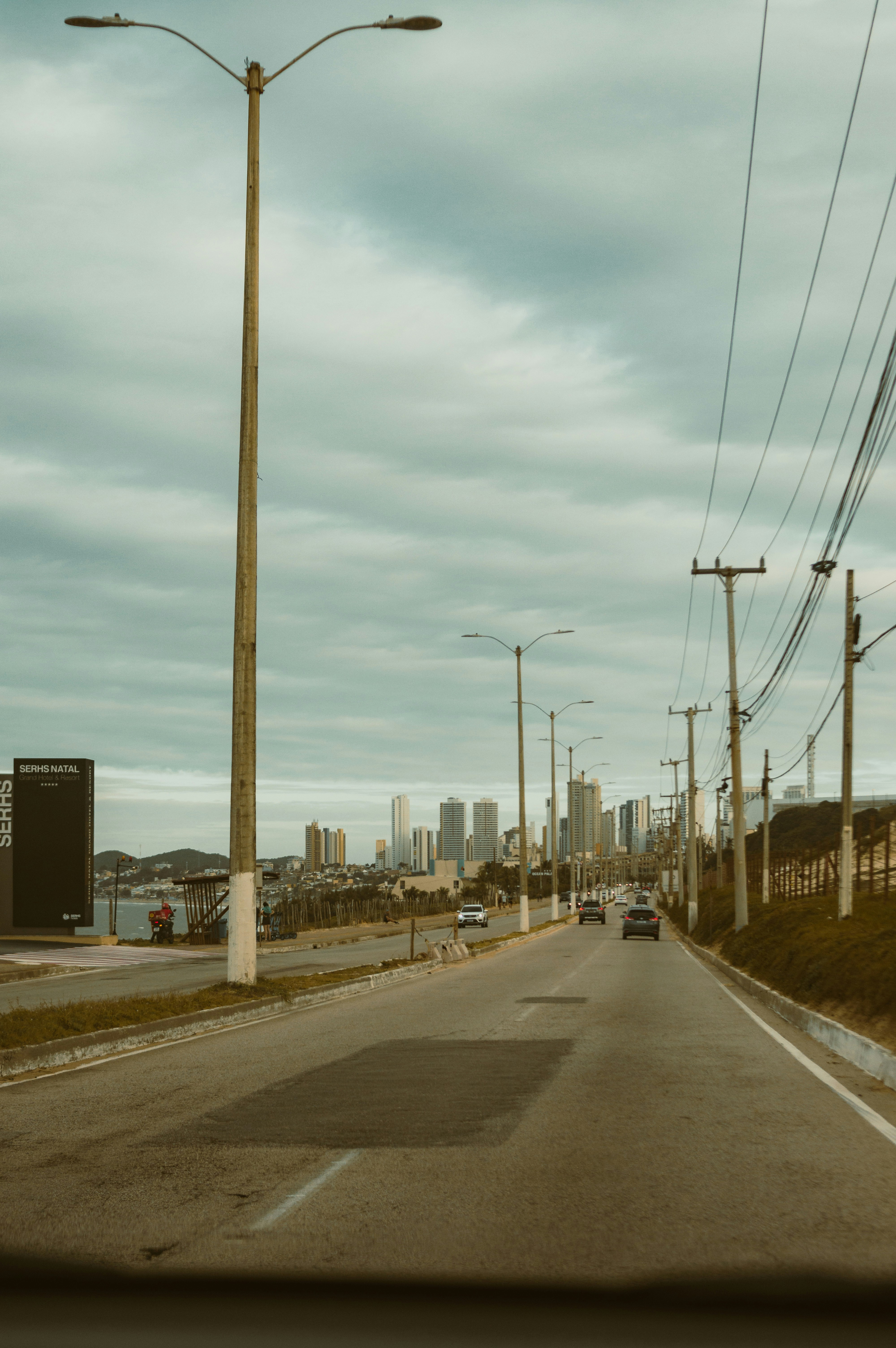 Urban Spine: A Coastal Road Toward a Distant Skyline