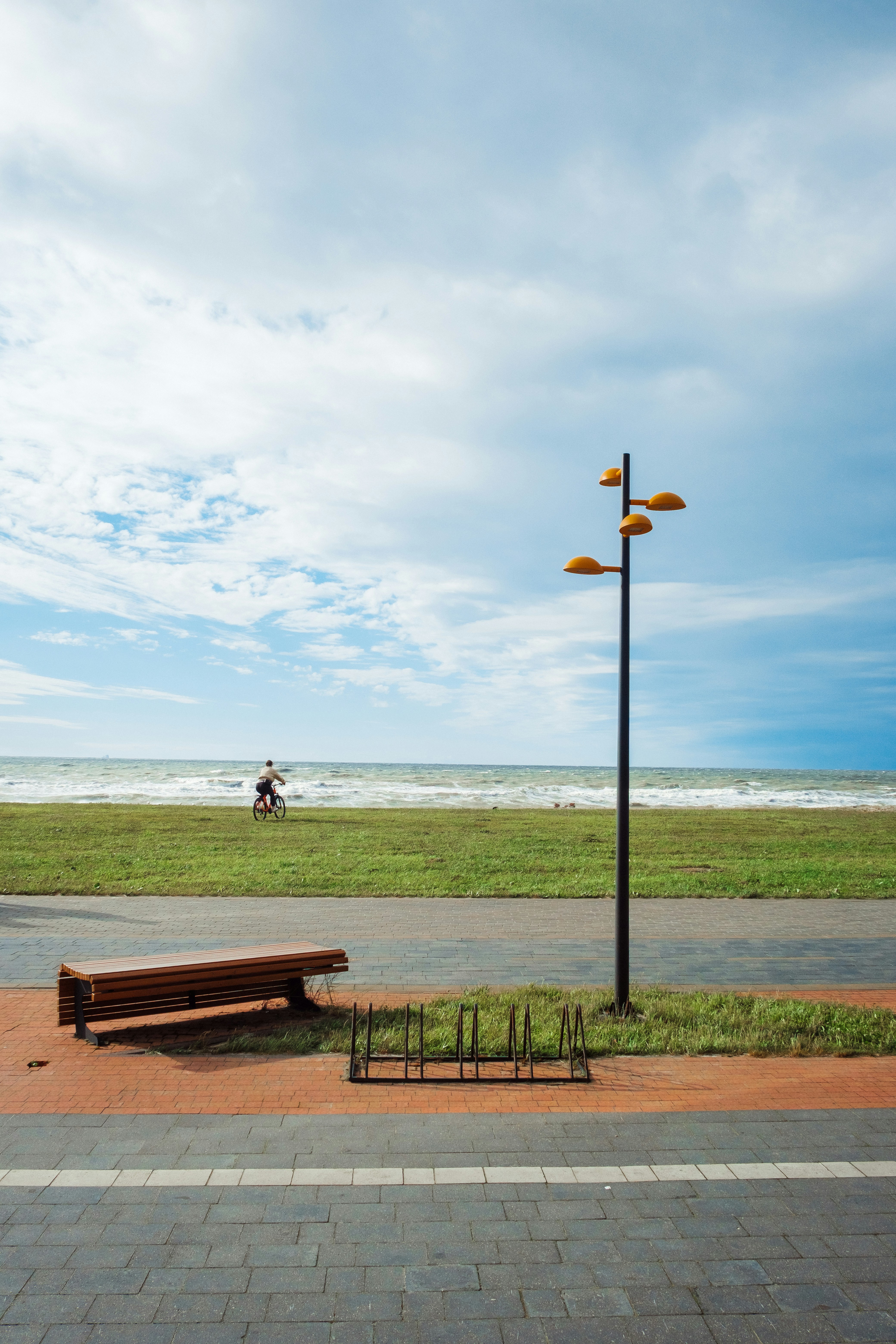 Seaside Pause: A Lone Cyclist by the Dune Edge